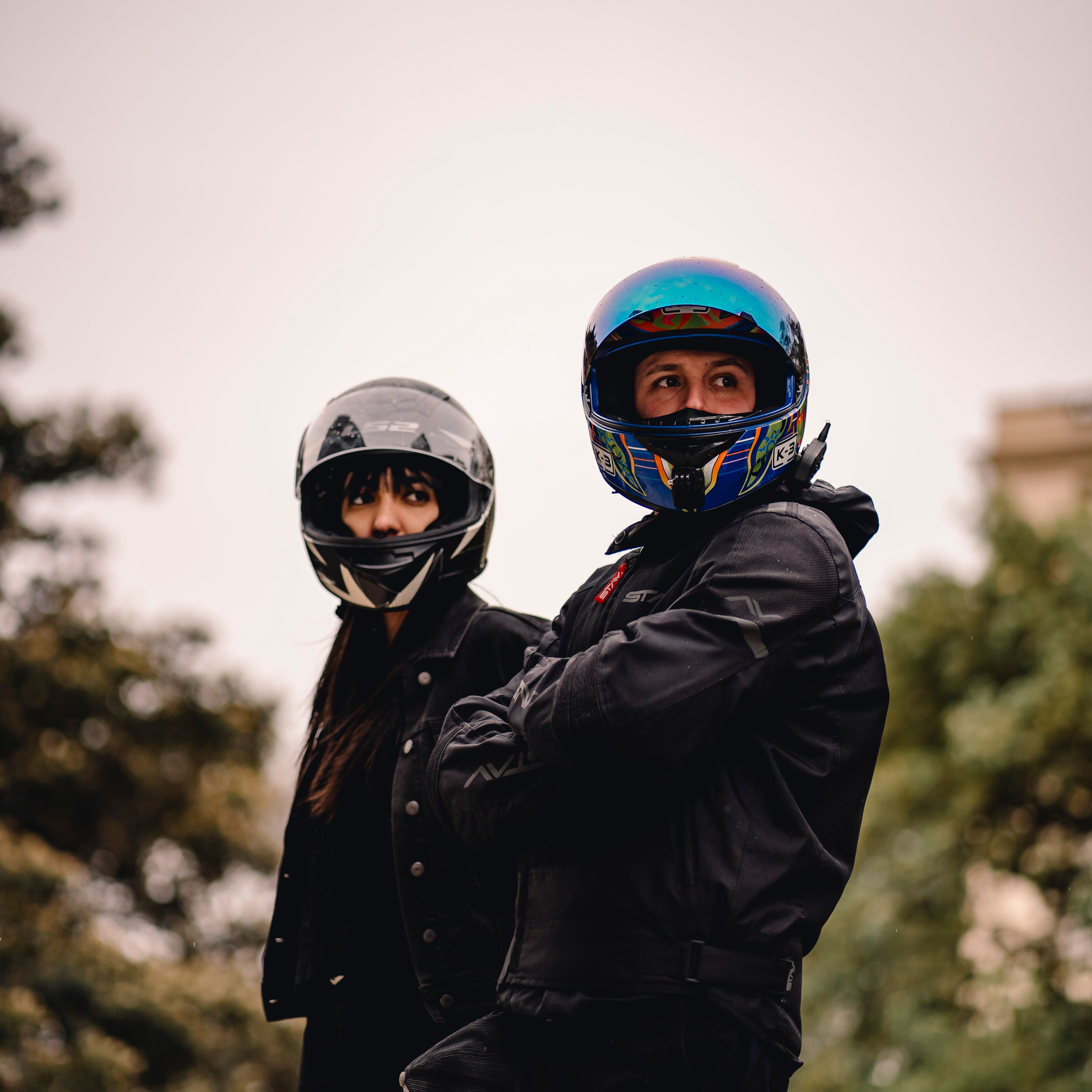 Woman and Man Posing in Biker Gear and Helmet · Free Stock Photo