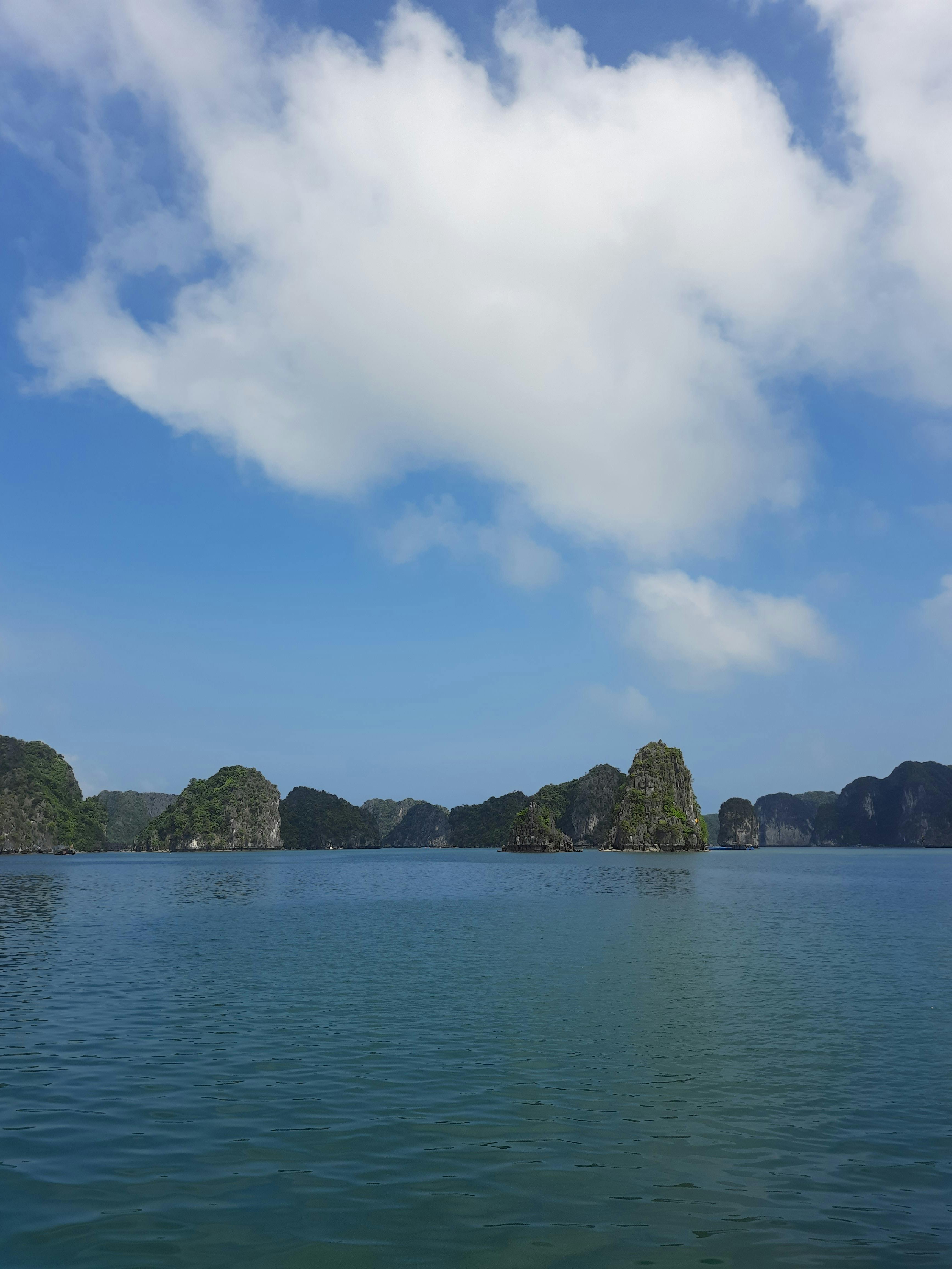 Passenger Ships Sailing among Rocky Islets in Vietnam · Free Stock Photo