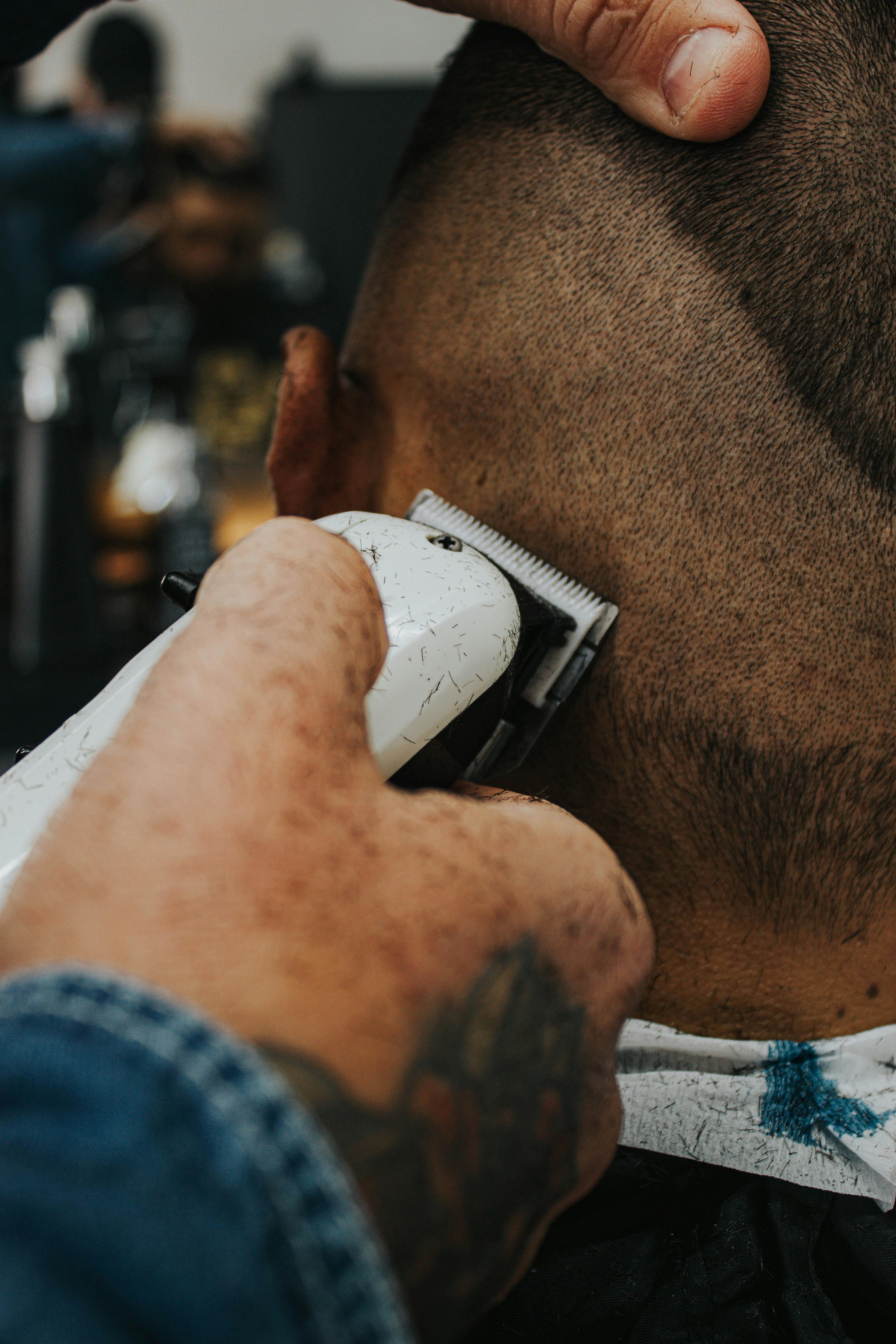 Cutting Hair with Electric Shaver in Close-up View · Free Stock Photo