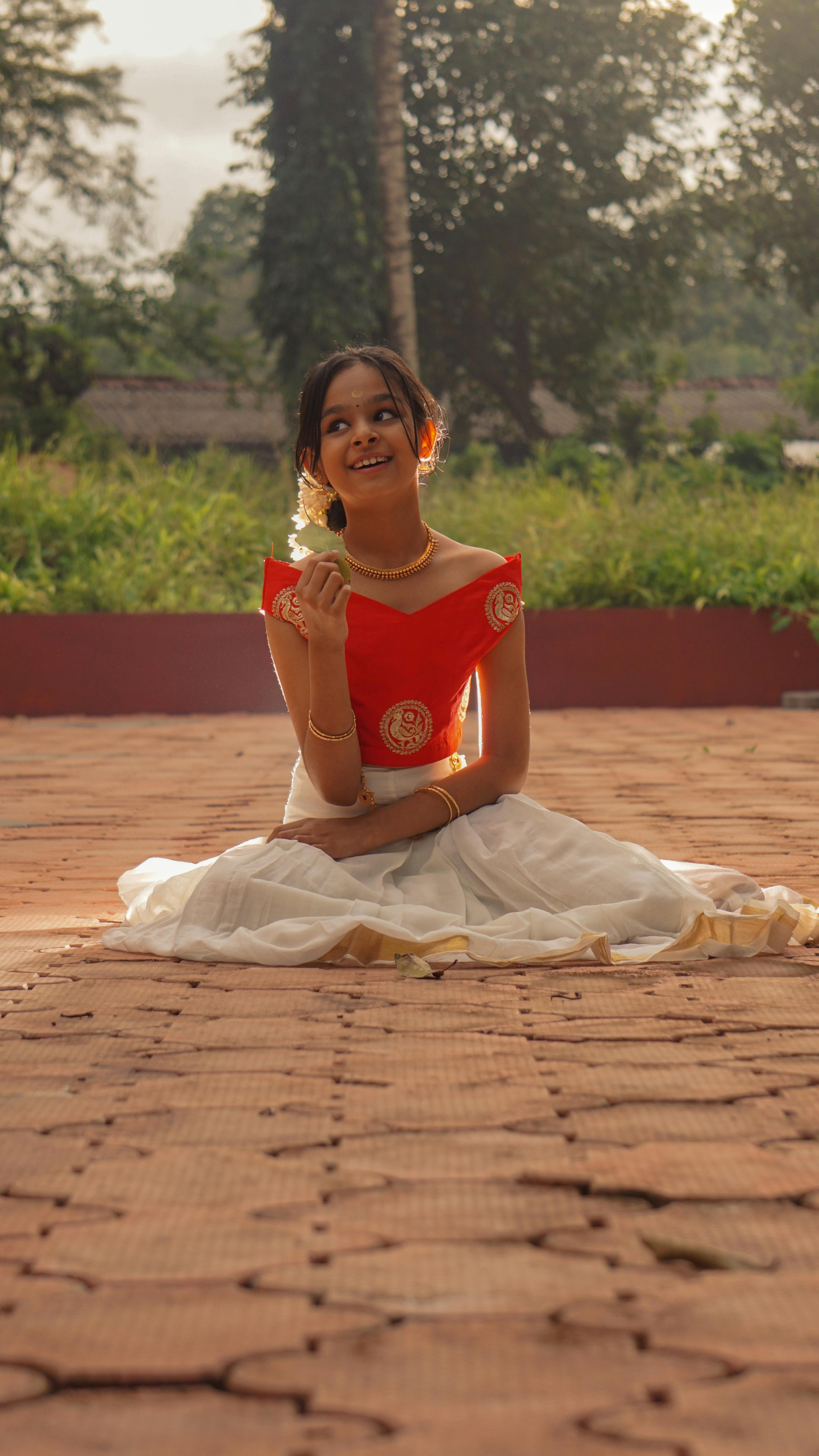 Smiling Girl Dressed in Choli Blouse and Ghagar Skirt Sitting on the ...