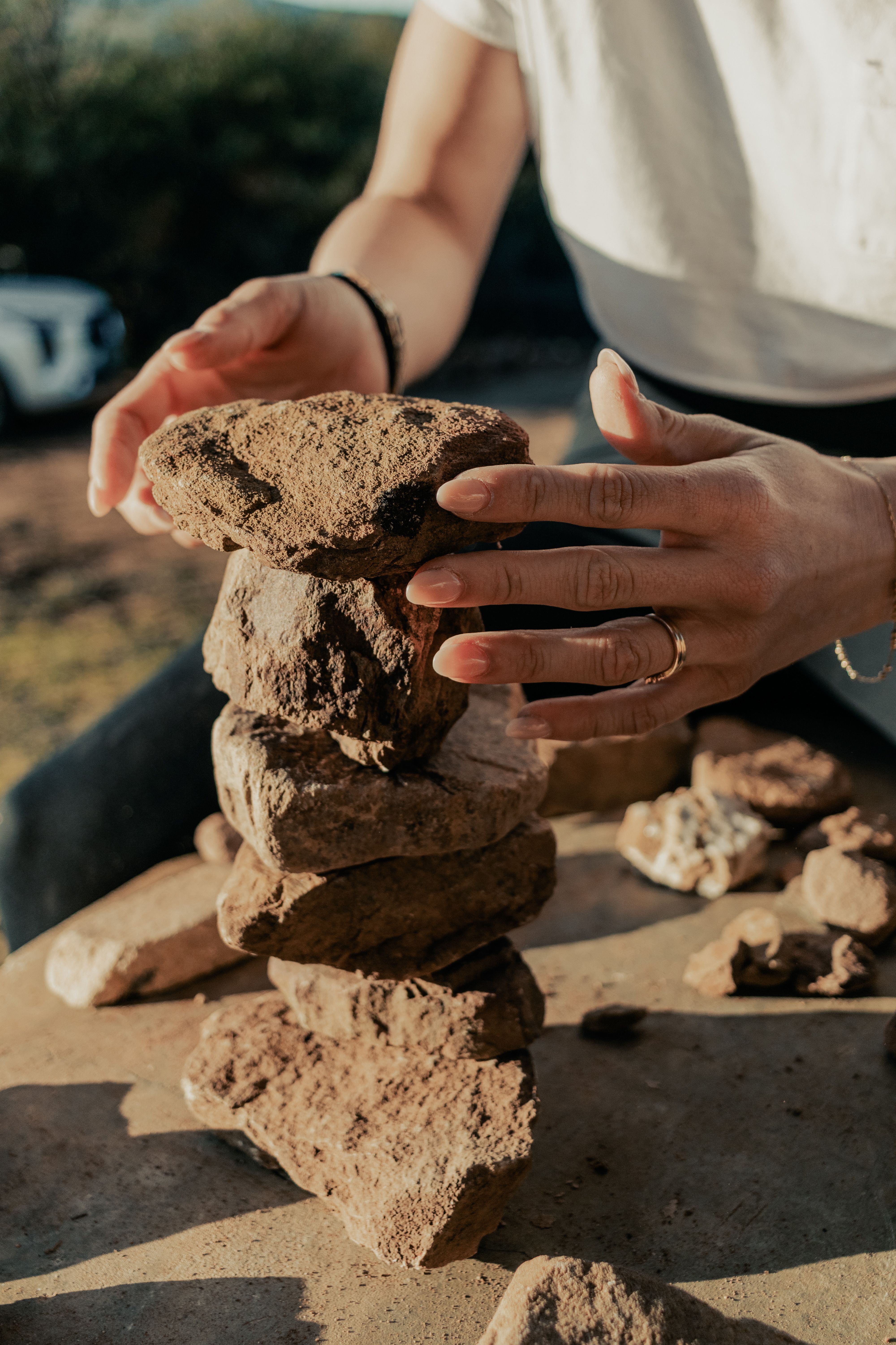 Woman Hands Putting Stones on Heap · Free Stock Photo