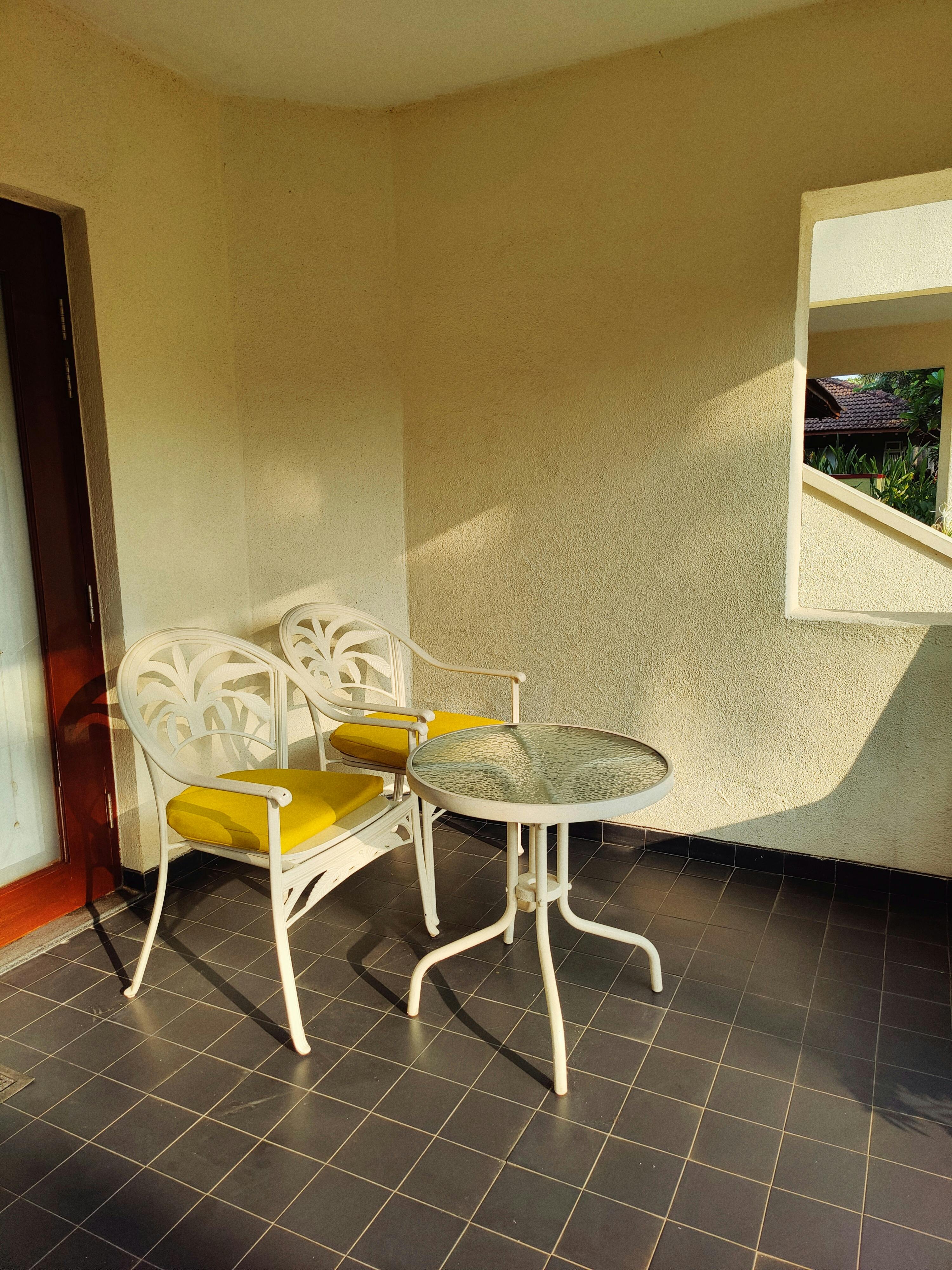Chairs and Table on a Balcony · Free Stock Photo