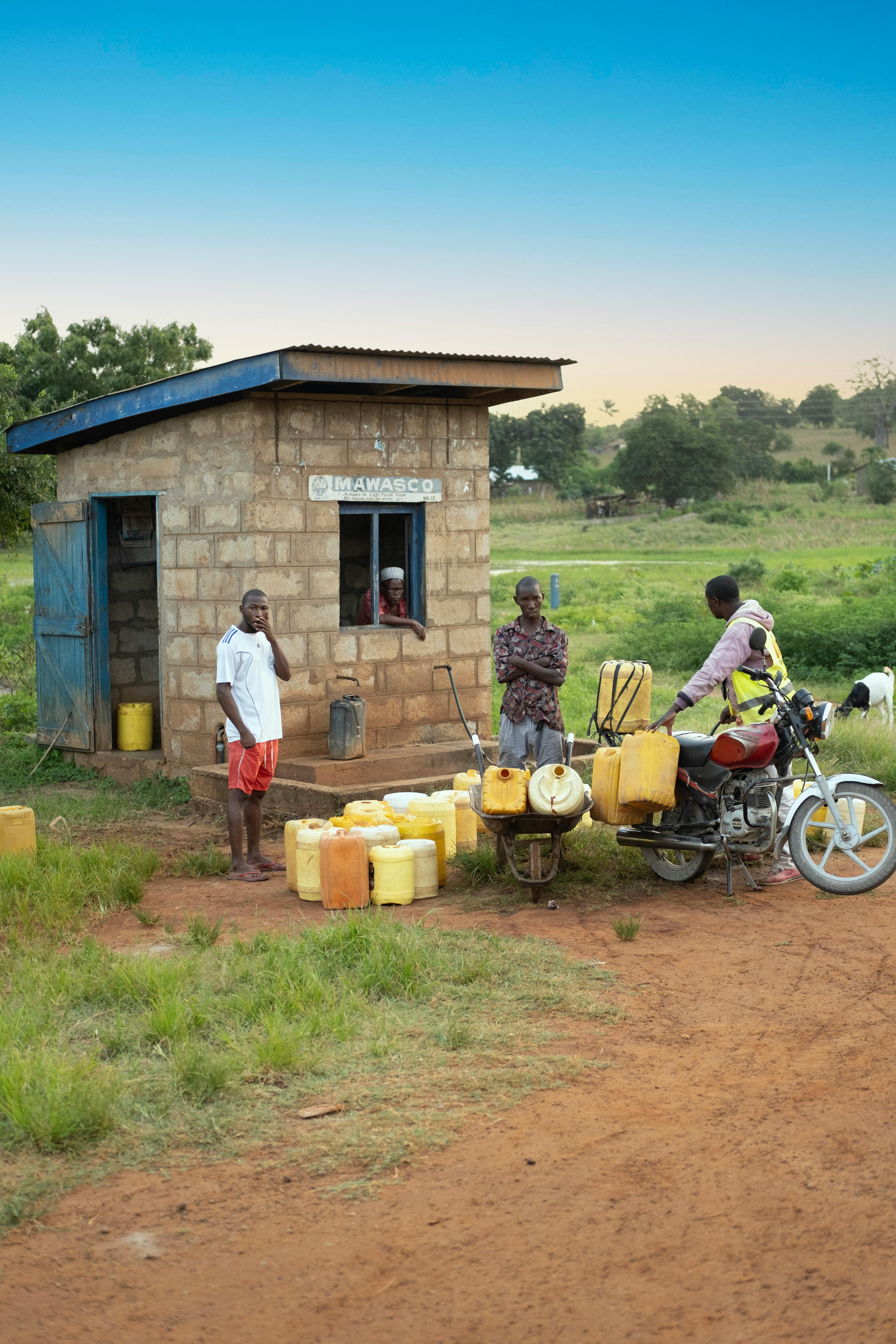 People Standing with Containers by Wells · Free Stock Photo