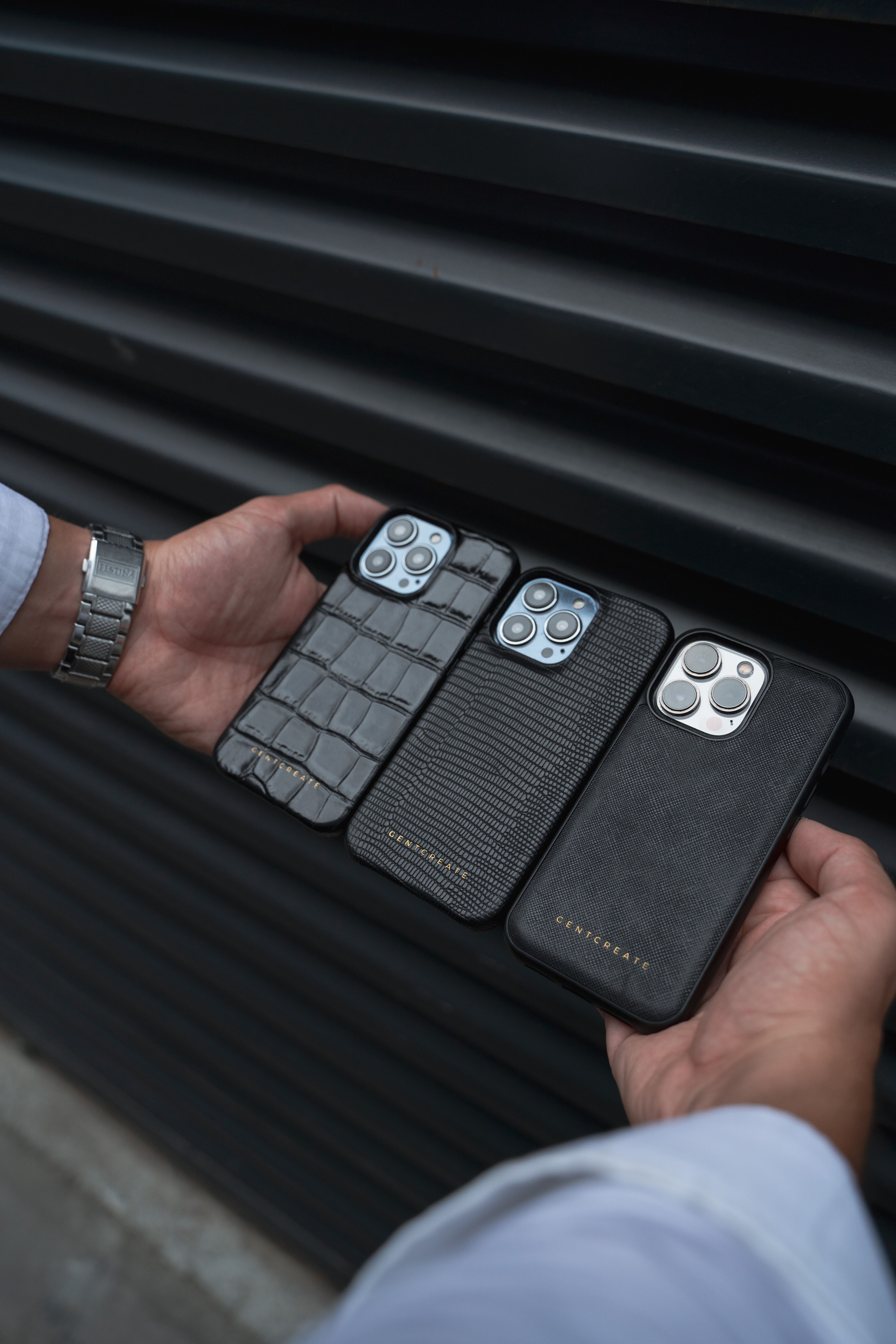 Holding iPhones 14 in Various Cases · Free Stock Photo