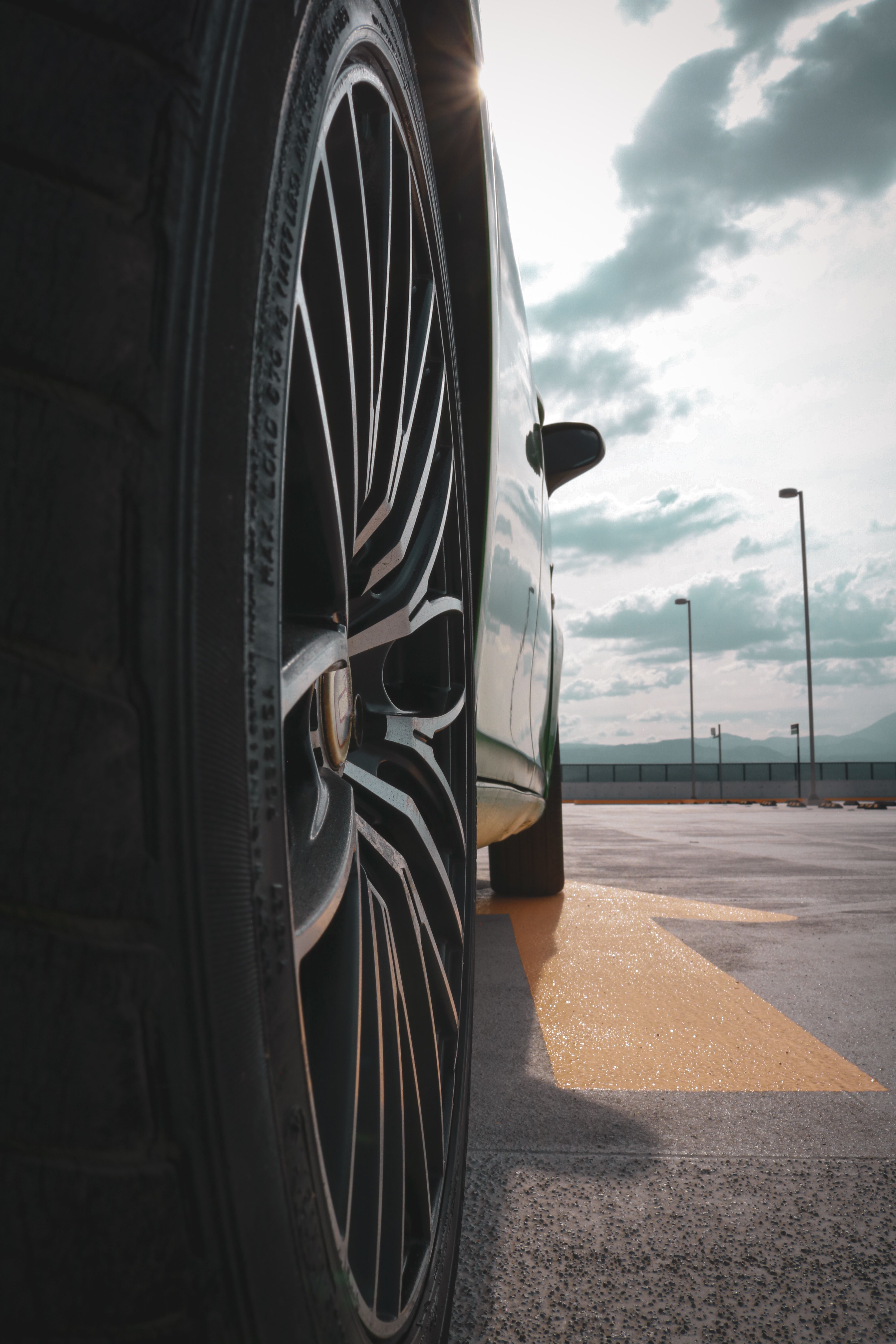 Wheel of Car on Parking Lot · Free Stock Photo