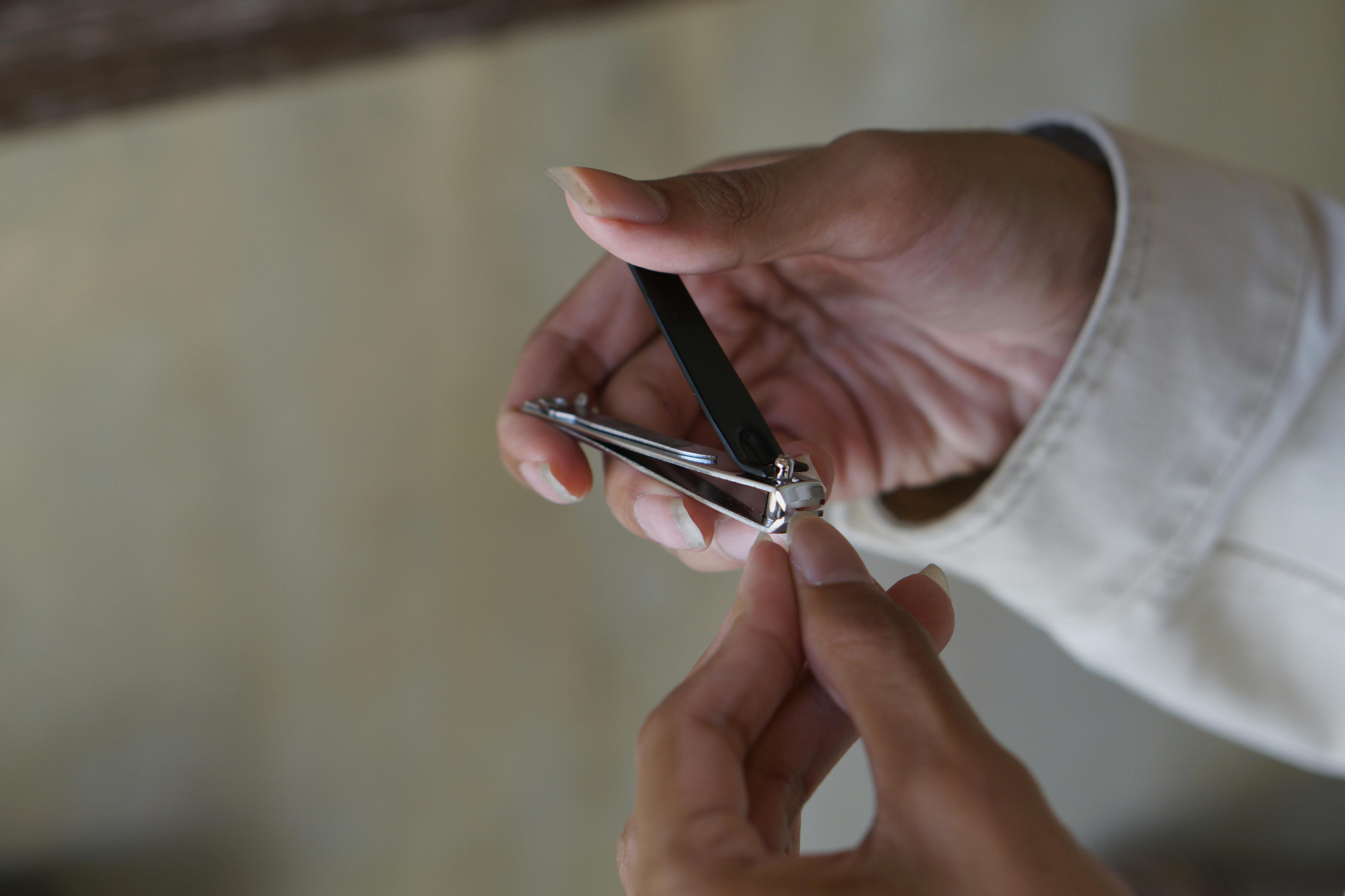 Close up of a man cutting his fingernail using nail clipper · Free ...