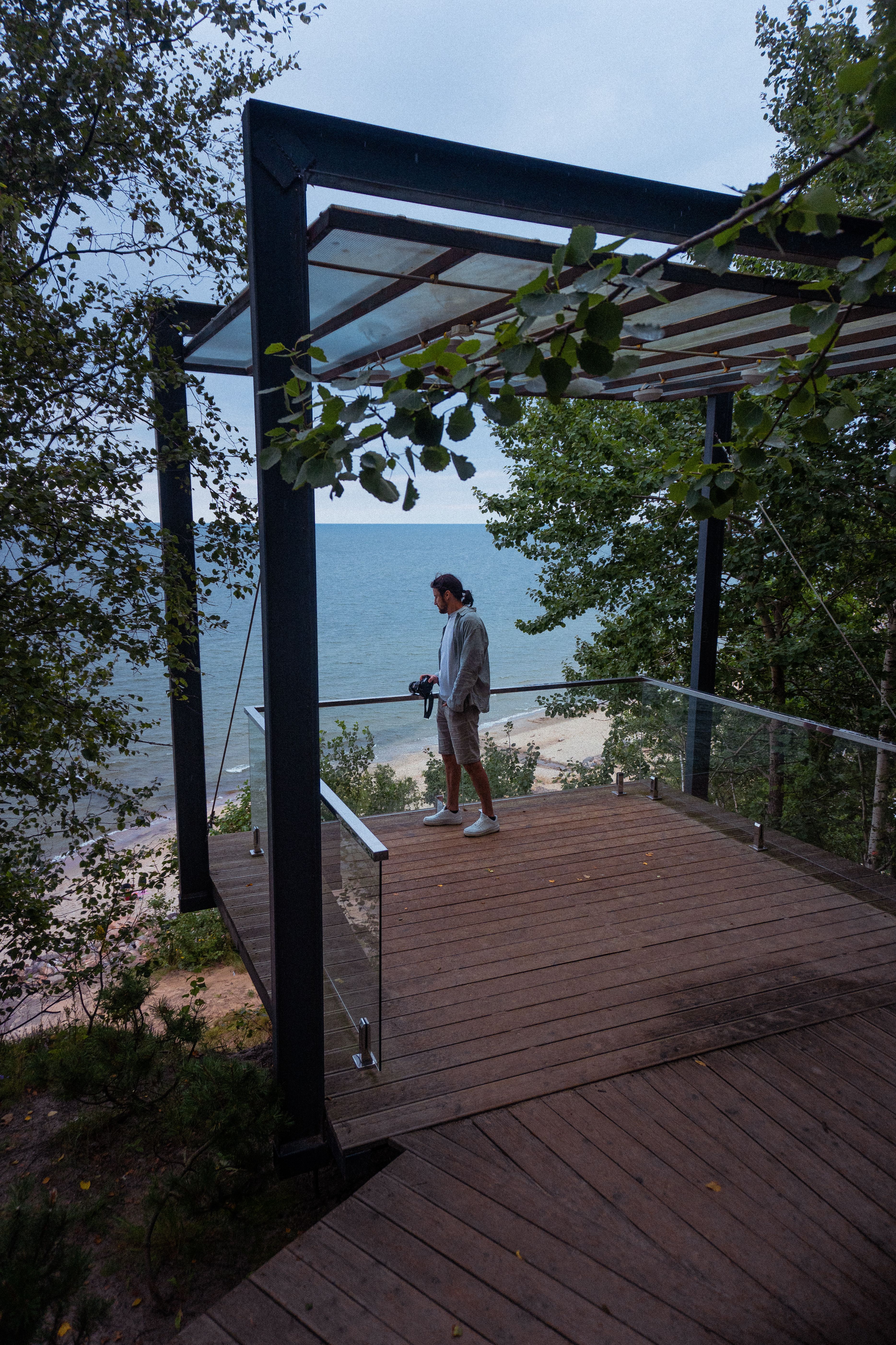 Man with a Photo Camera Standing on an Observation Deck over a Beach ...