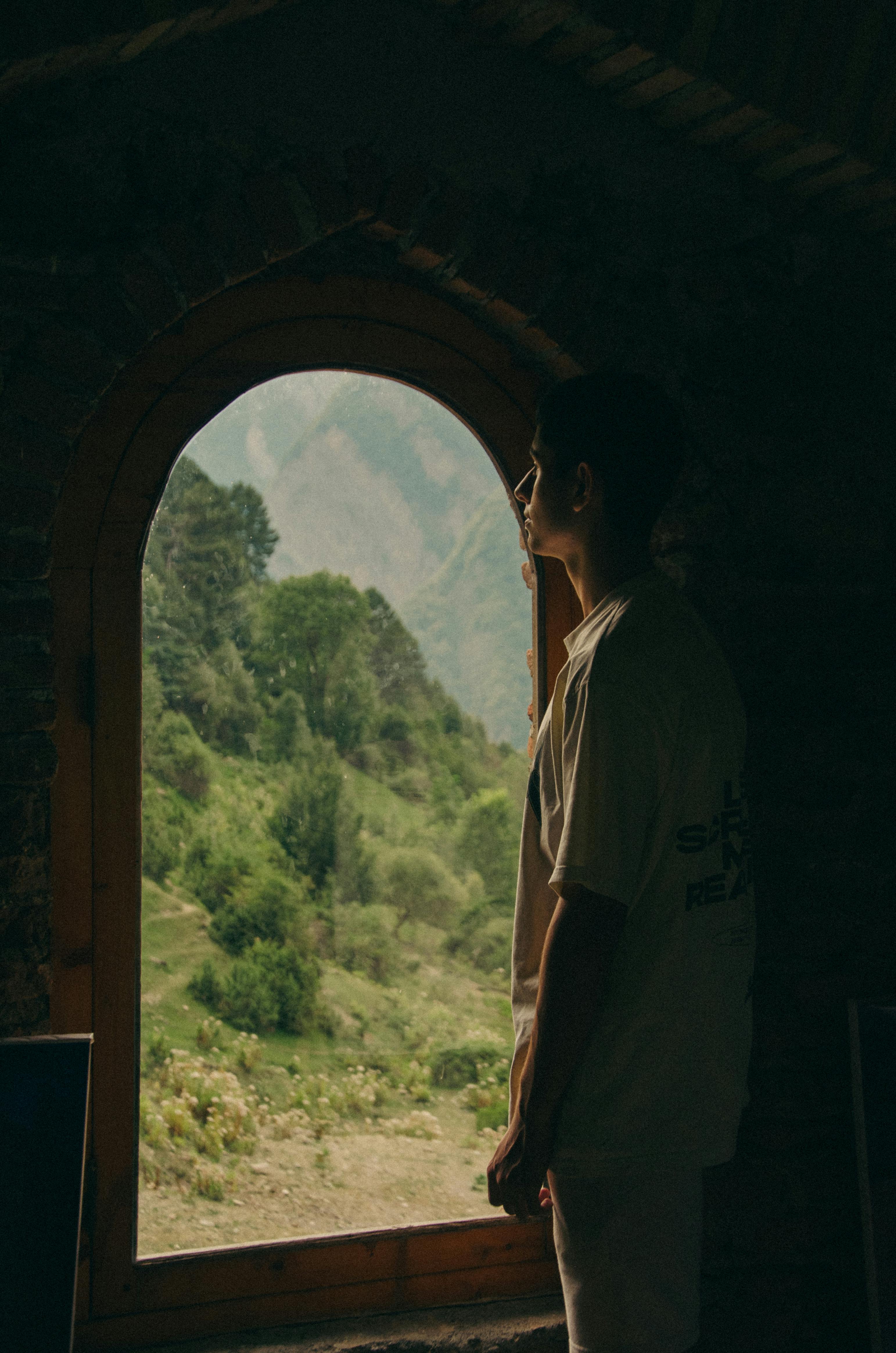 Man Standing near Window with Trees behind · Free Stock Photo