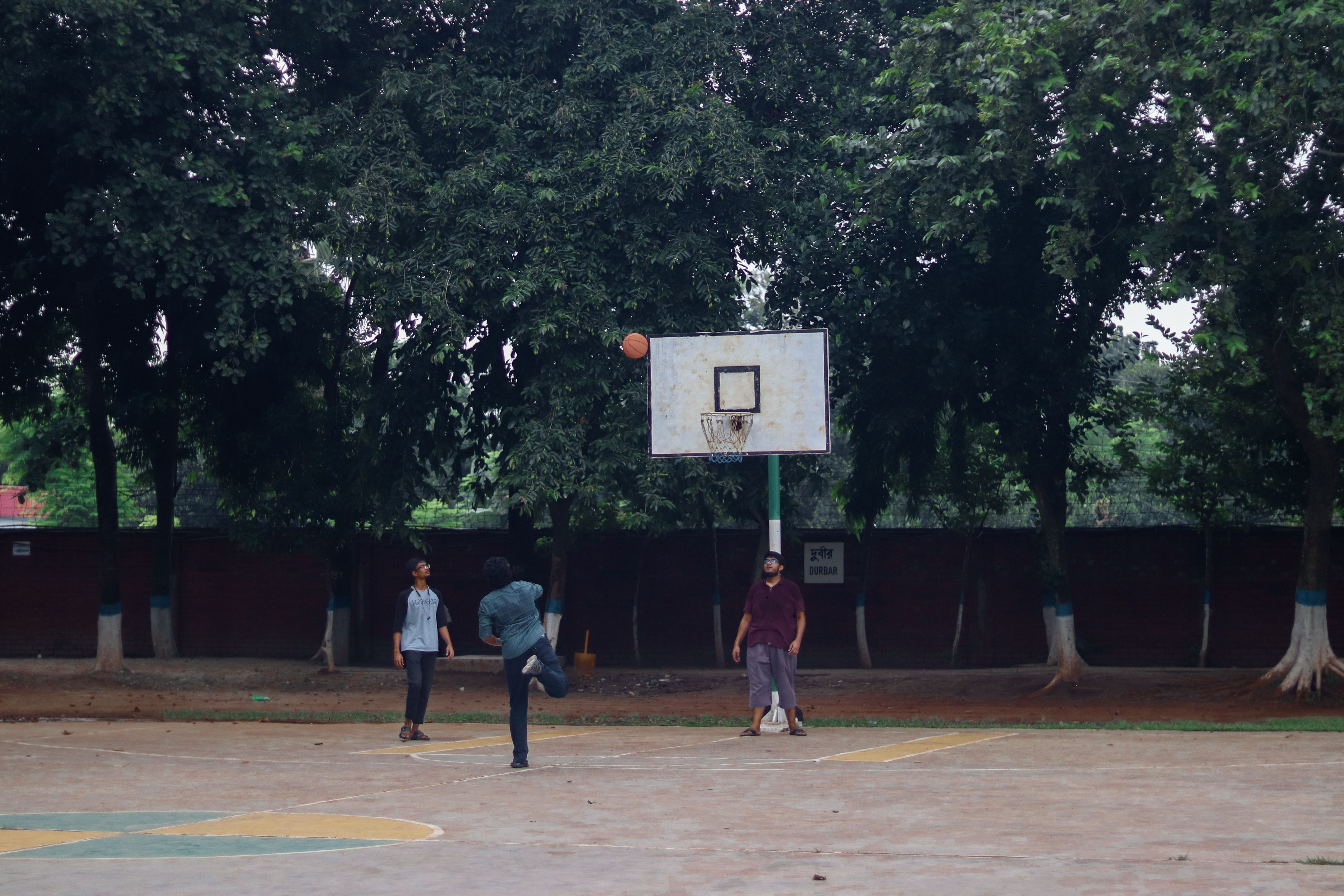 Young Men Playing Basketball in a Courtyard · Free Stock Photo