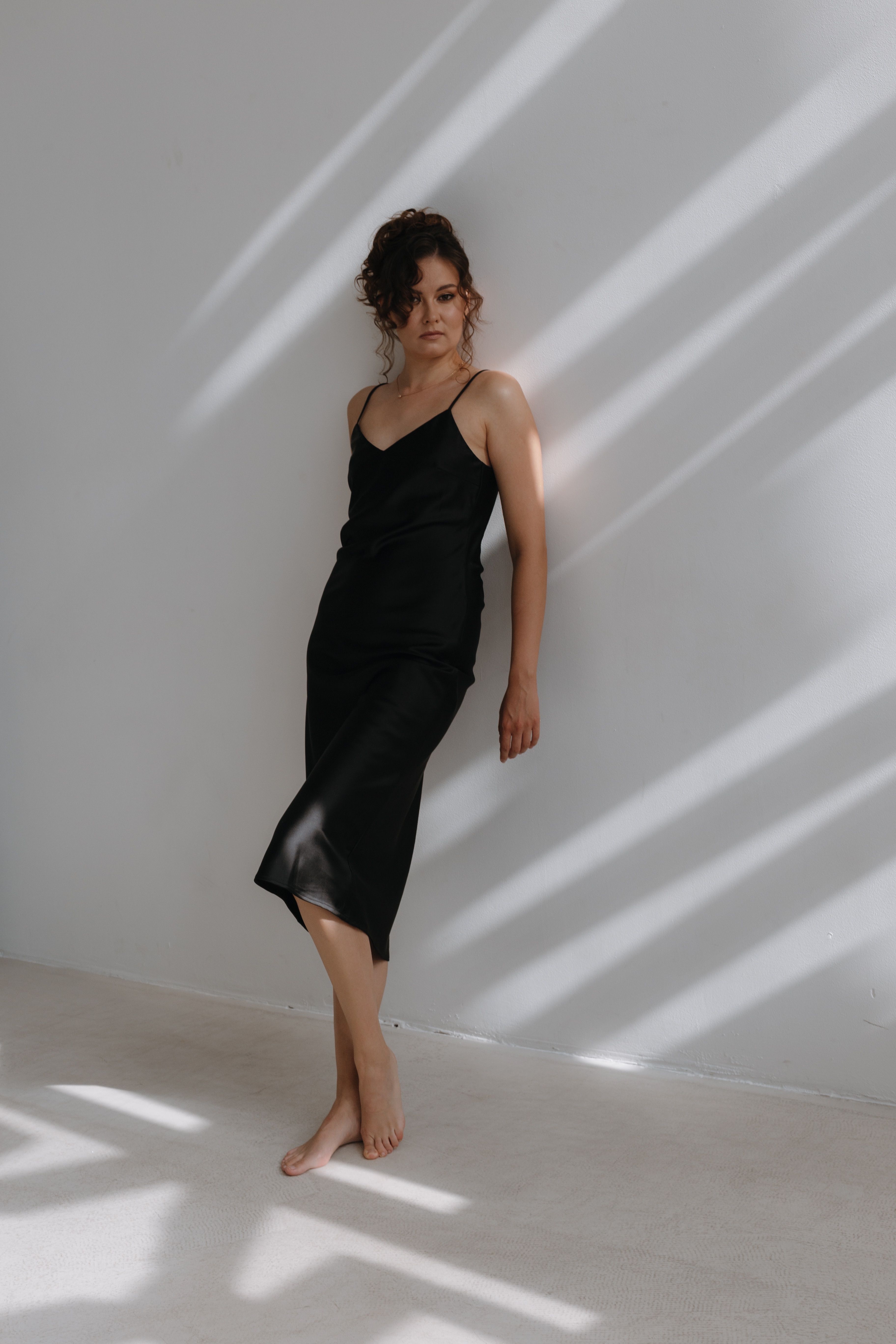 Woman in Black Spaghetti Straps Standing by Wall · Free Stock Photo
