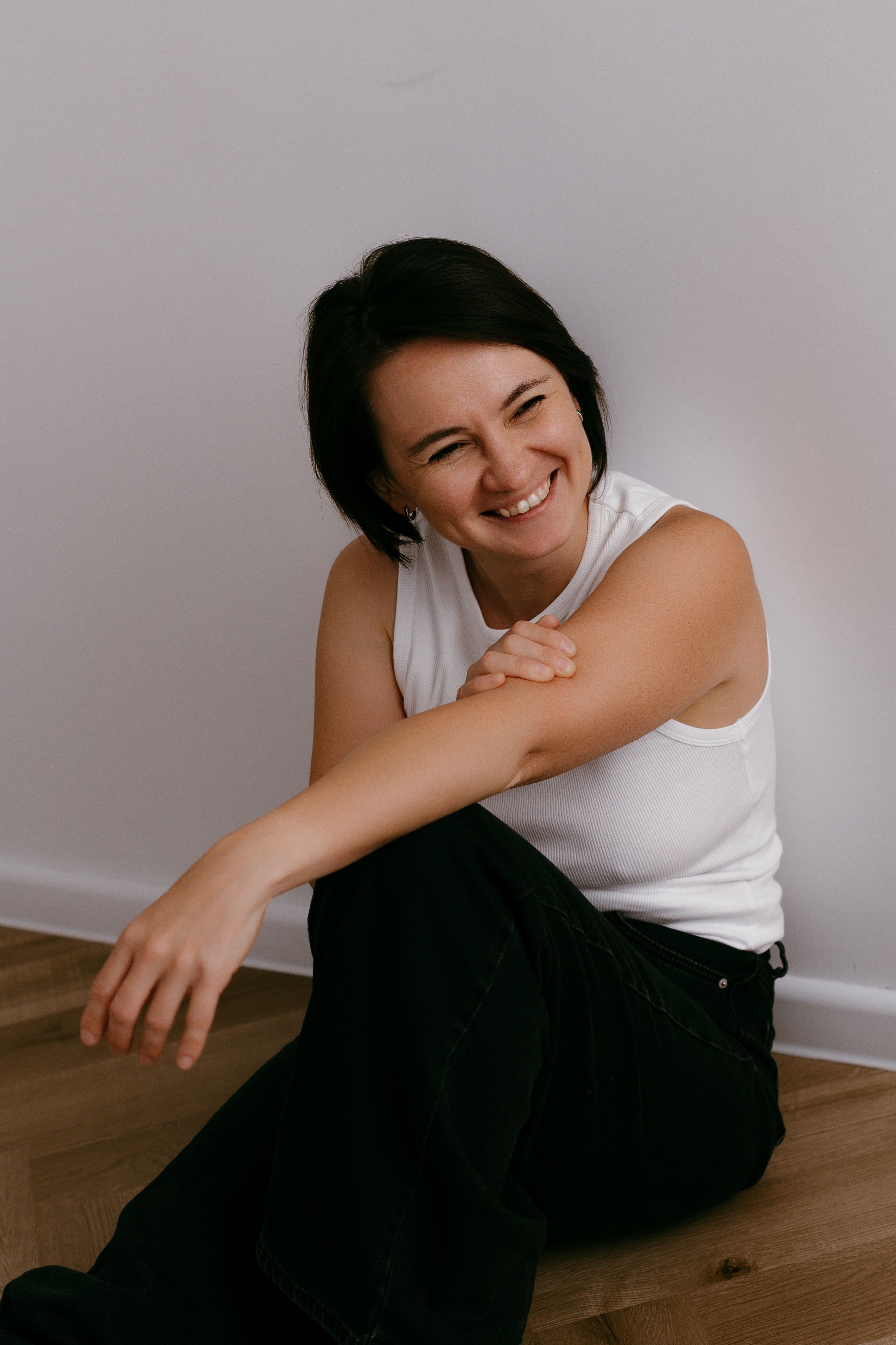 A Smiling Woman Wearing a White Tank Top · Free Stock Photo