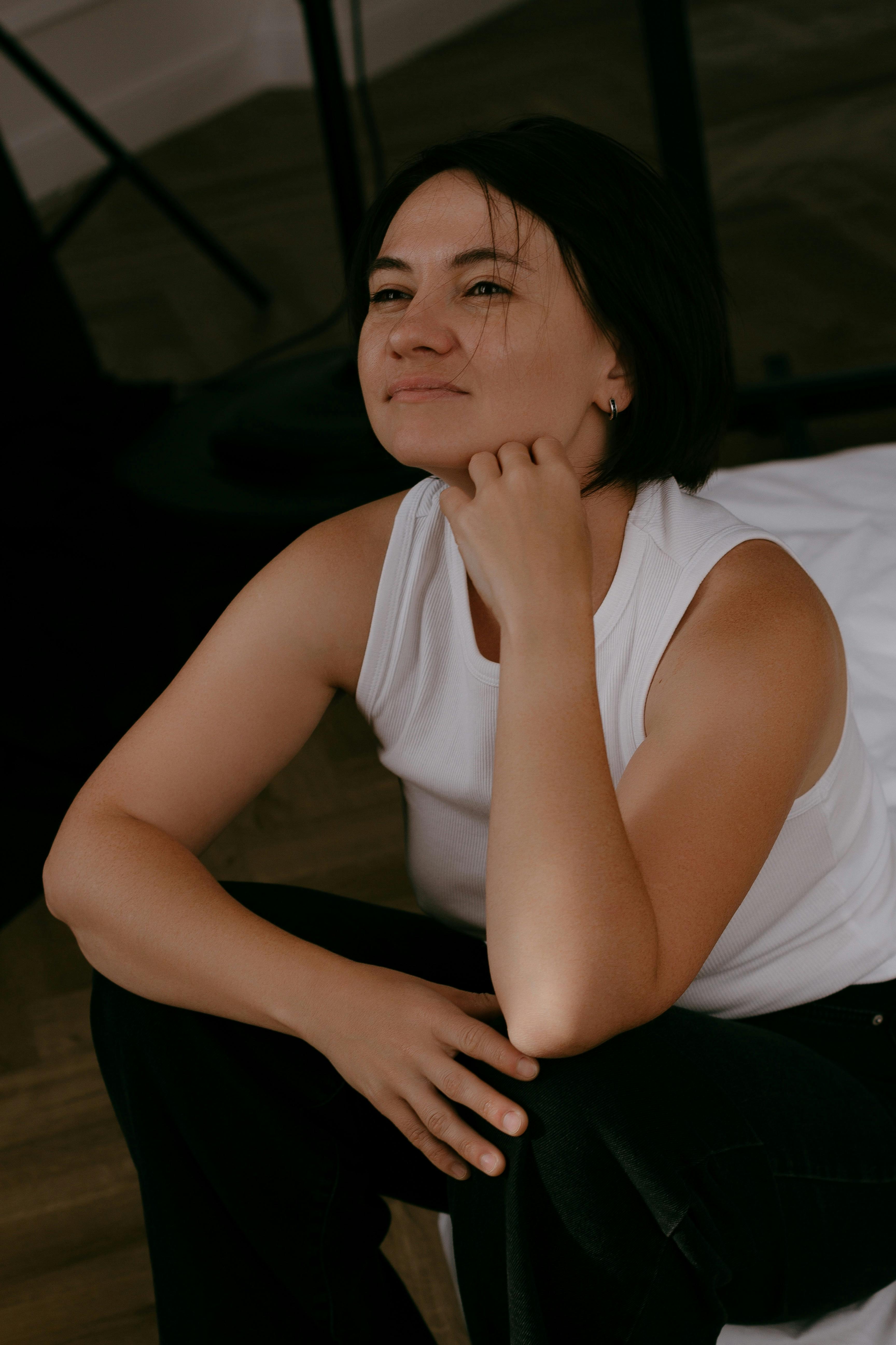 Woman in a Simple Outfit Sitting on a Chair · Free Stock Photo