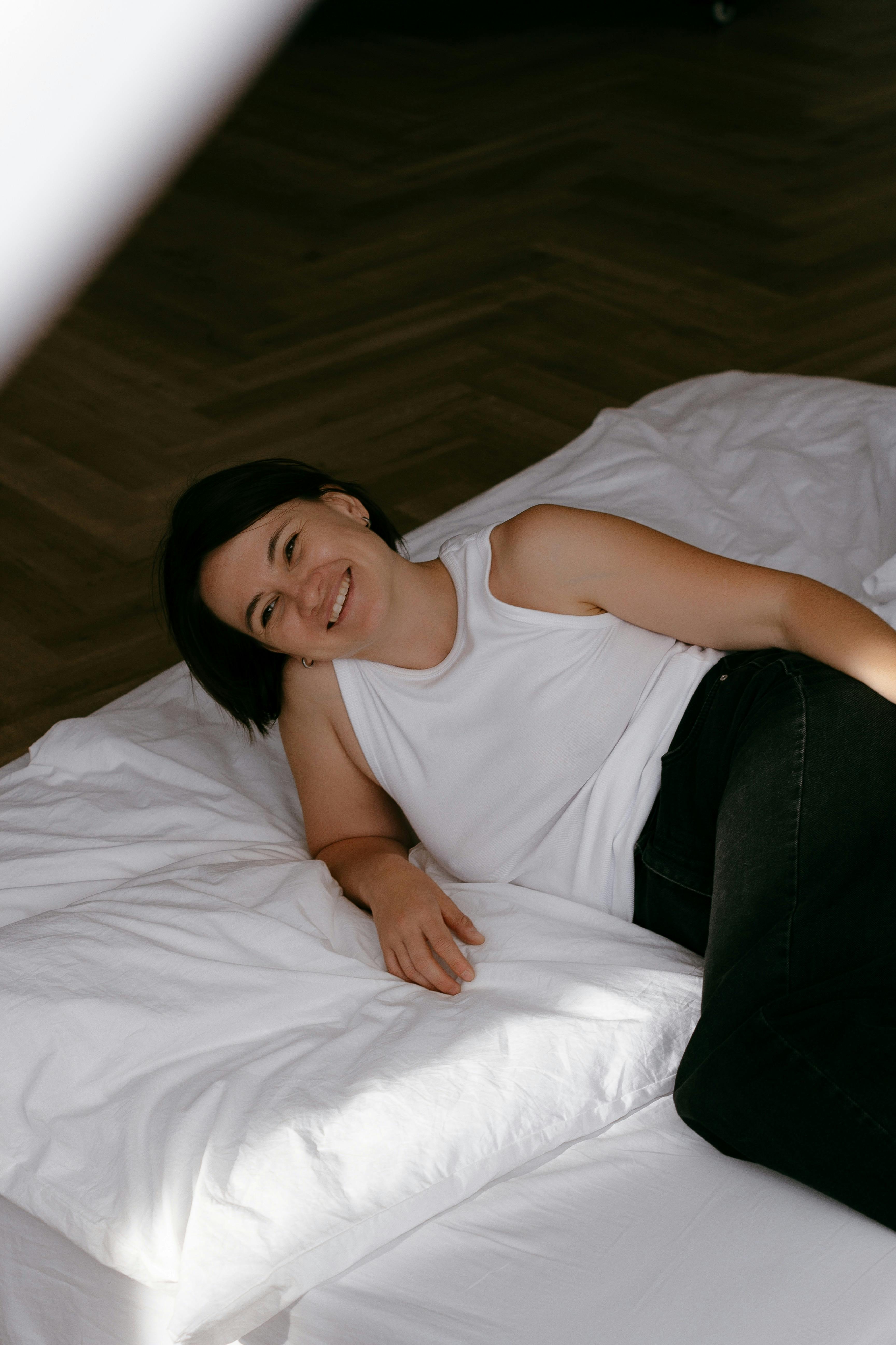 Happy Woman Lying on Mattress · Free Stock Photo