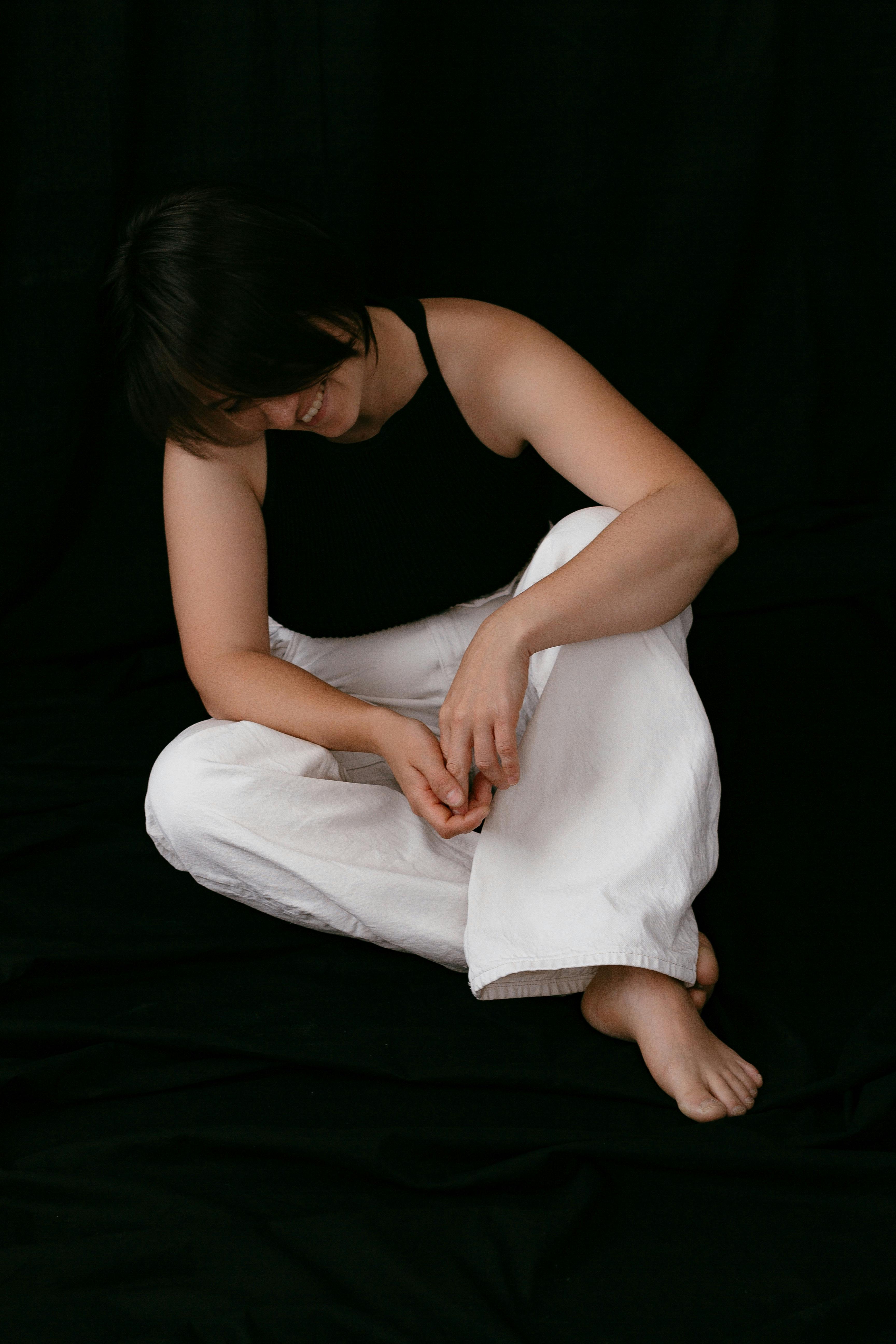 A Woman Sitting on Floor Hugging Leg · Free Stock Photo