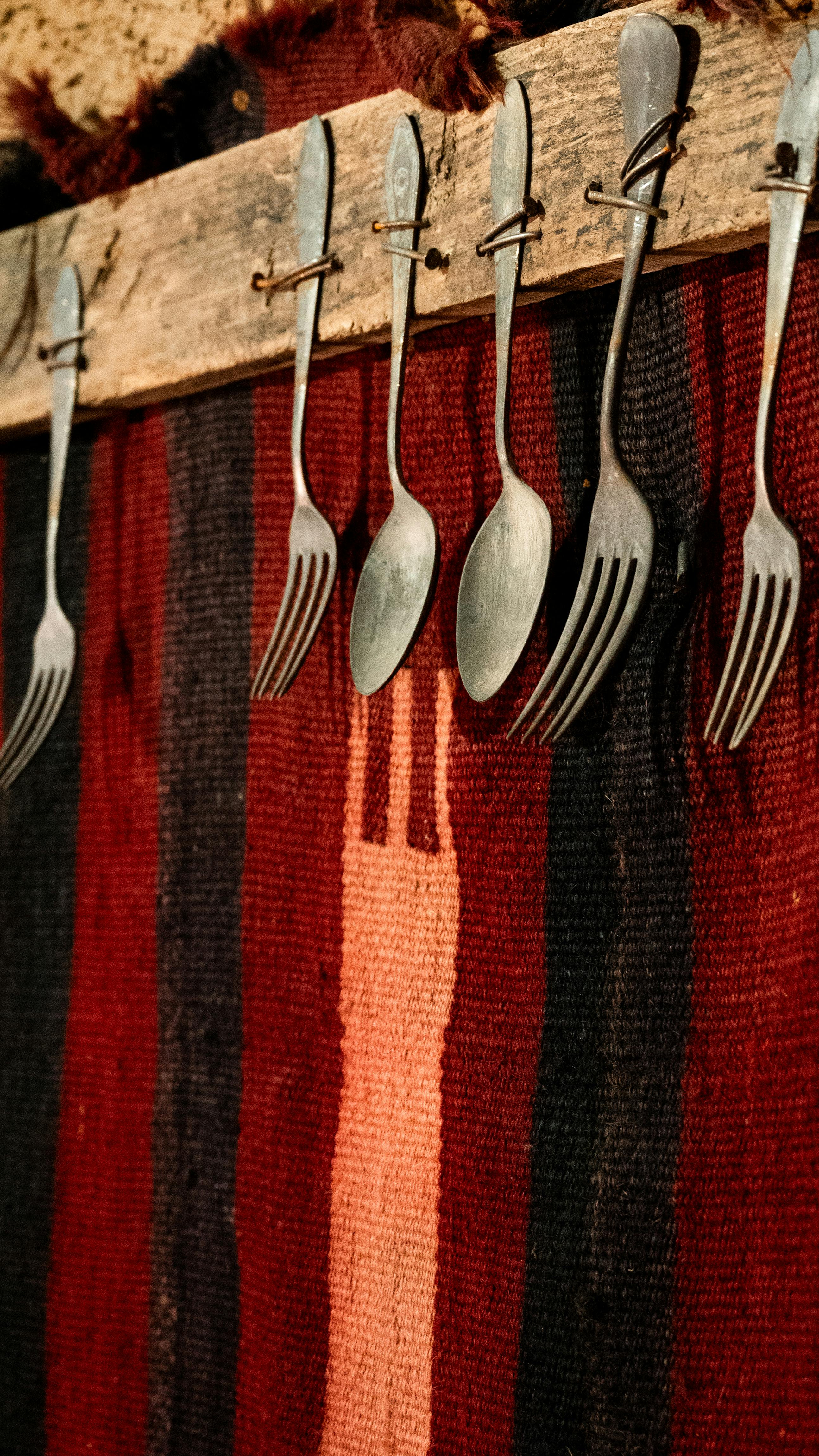 Forks and Spoons Hanging on Plank · Free Stock Photo