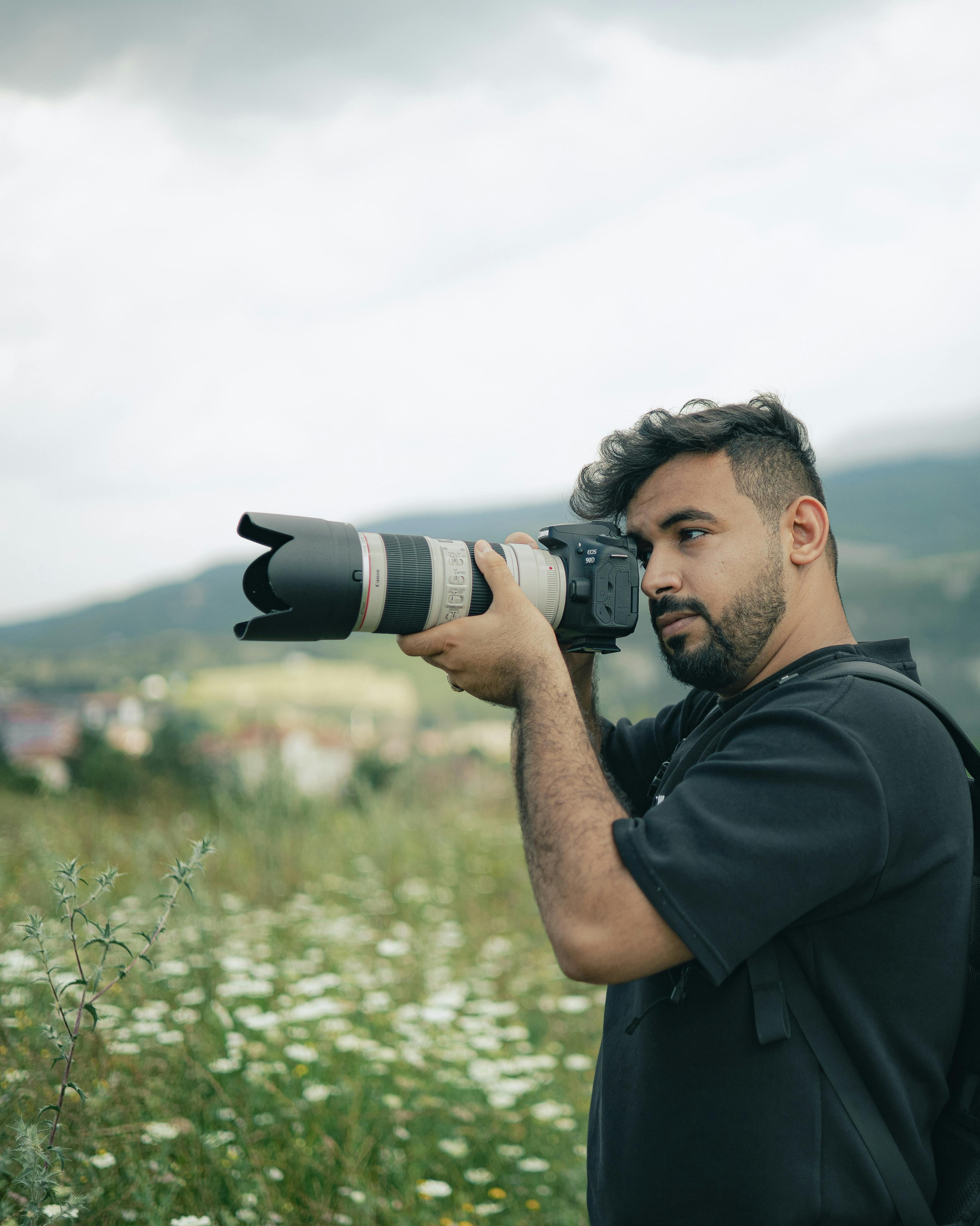 Person Holding Black Dslr Camera · Free Stock Photo
