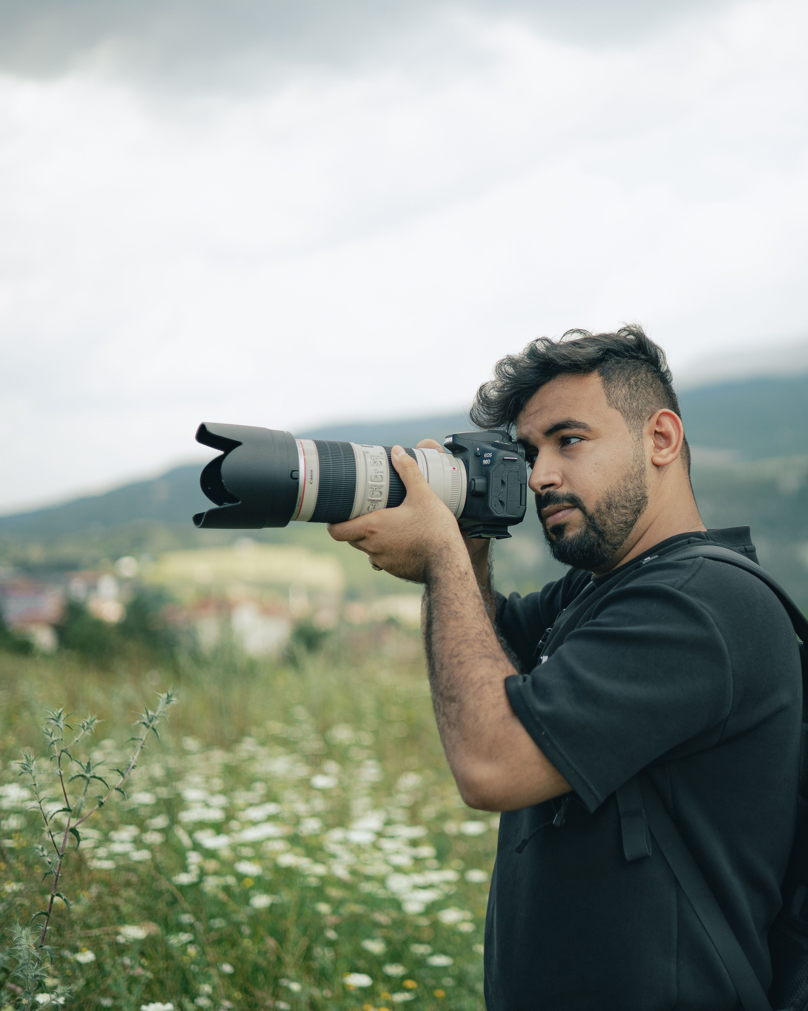Photo of Man Standing in Alley Holding Dslr Camera Looking at Photos ...