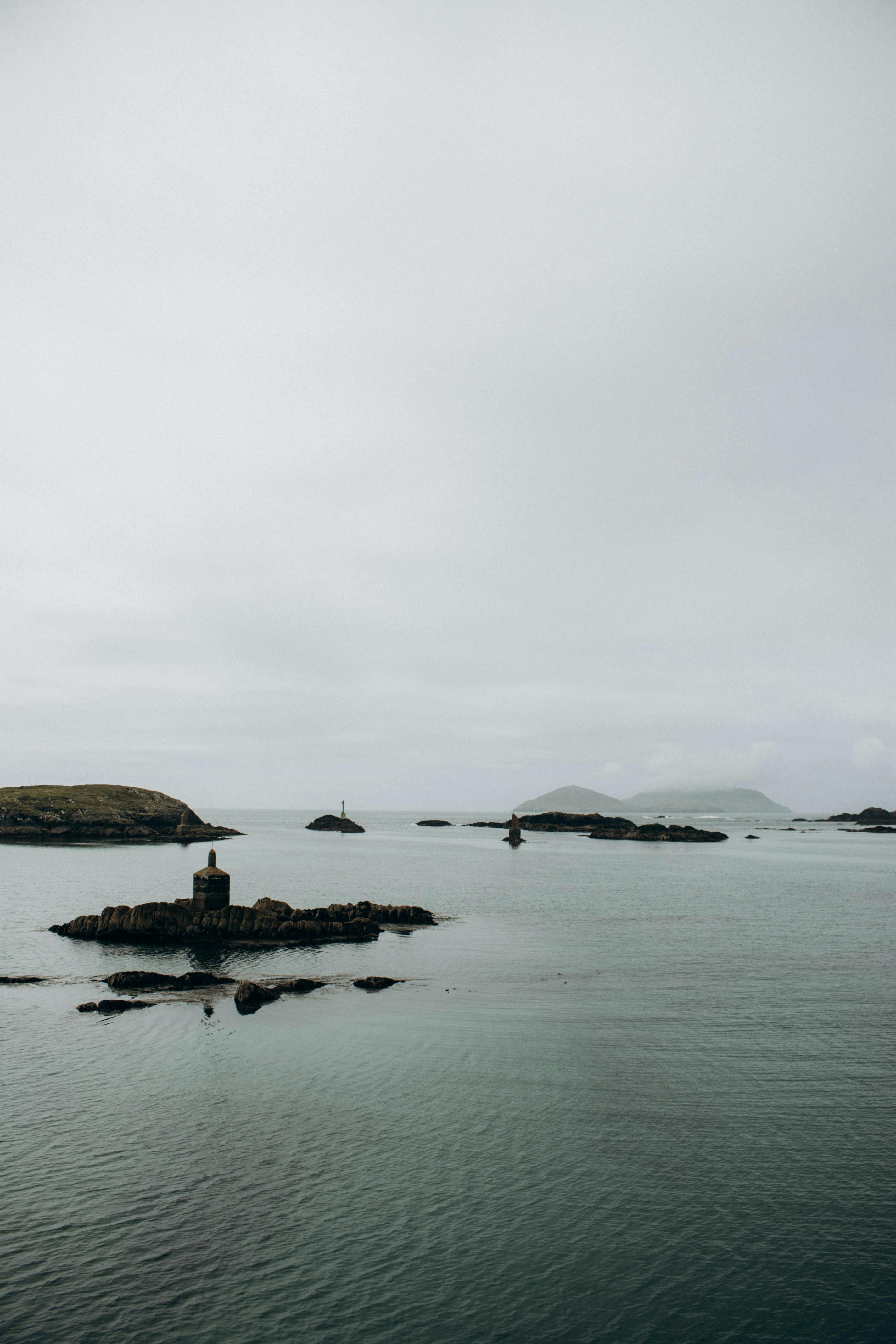 Rocky Islet in a Bay Surrounded by Mountains · Free Stock Photo