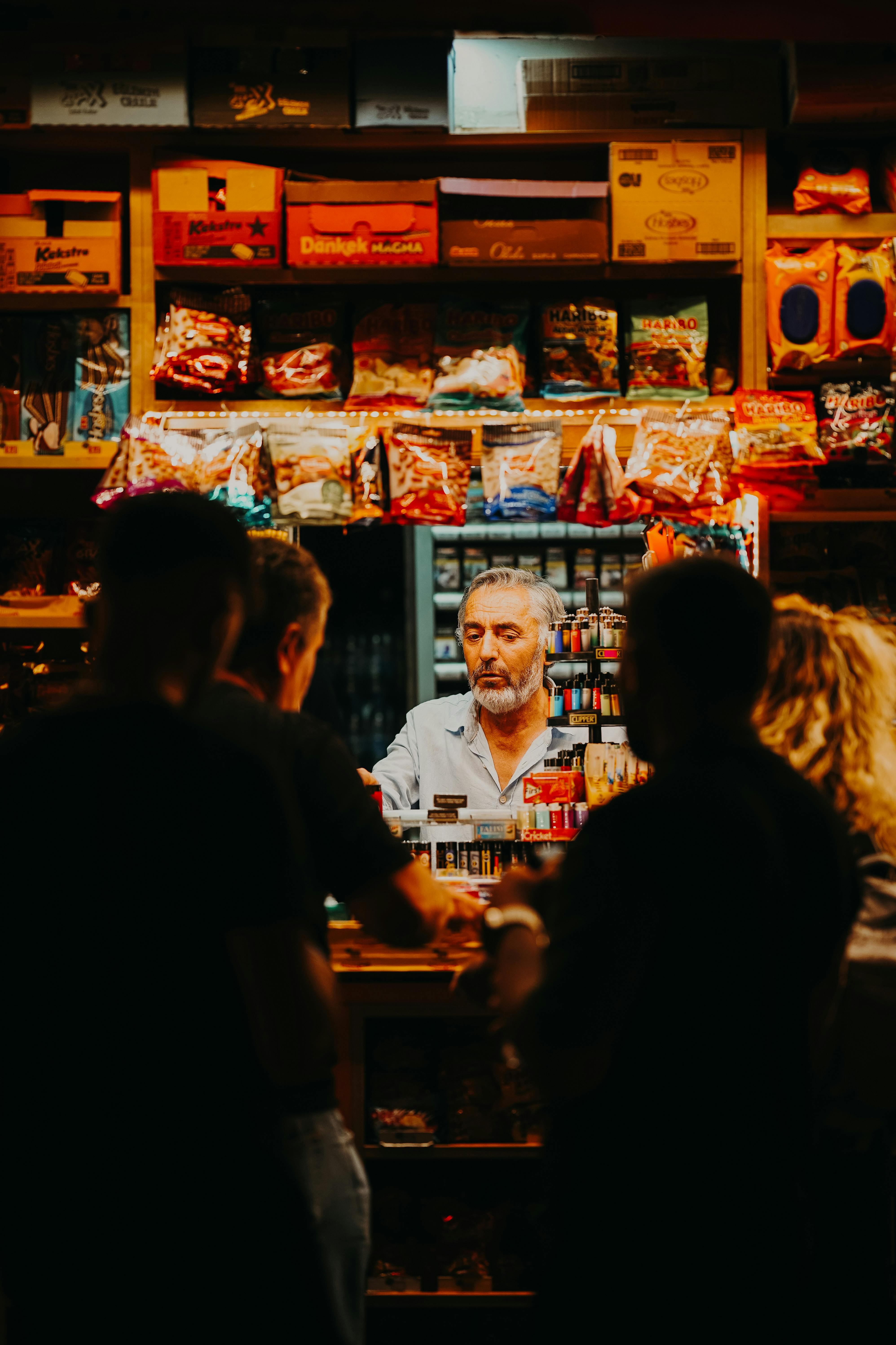 Salesman Standing at Counter in Store · Free Stock Photo