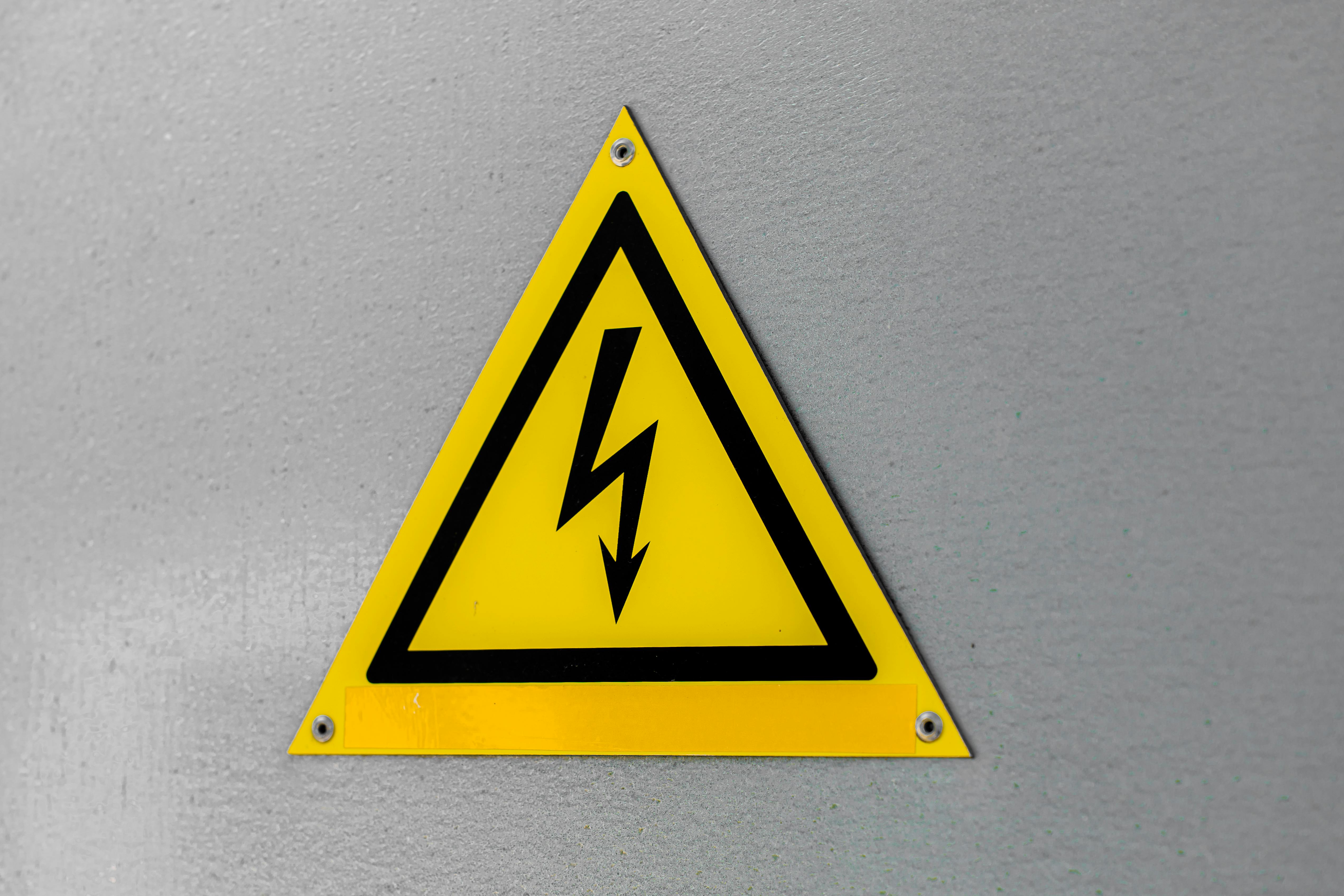 A yellow and black warning sign with an electrical symbol · Free Stock ...