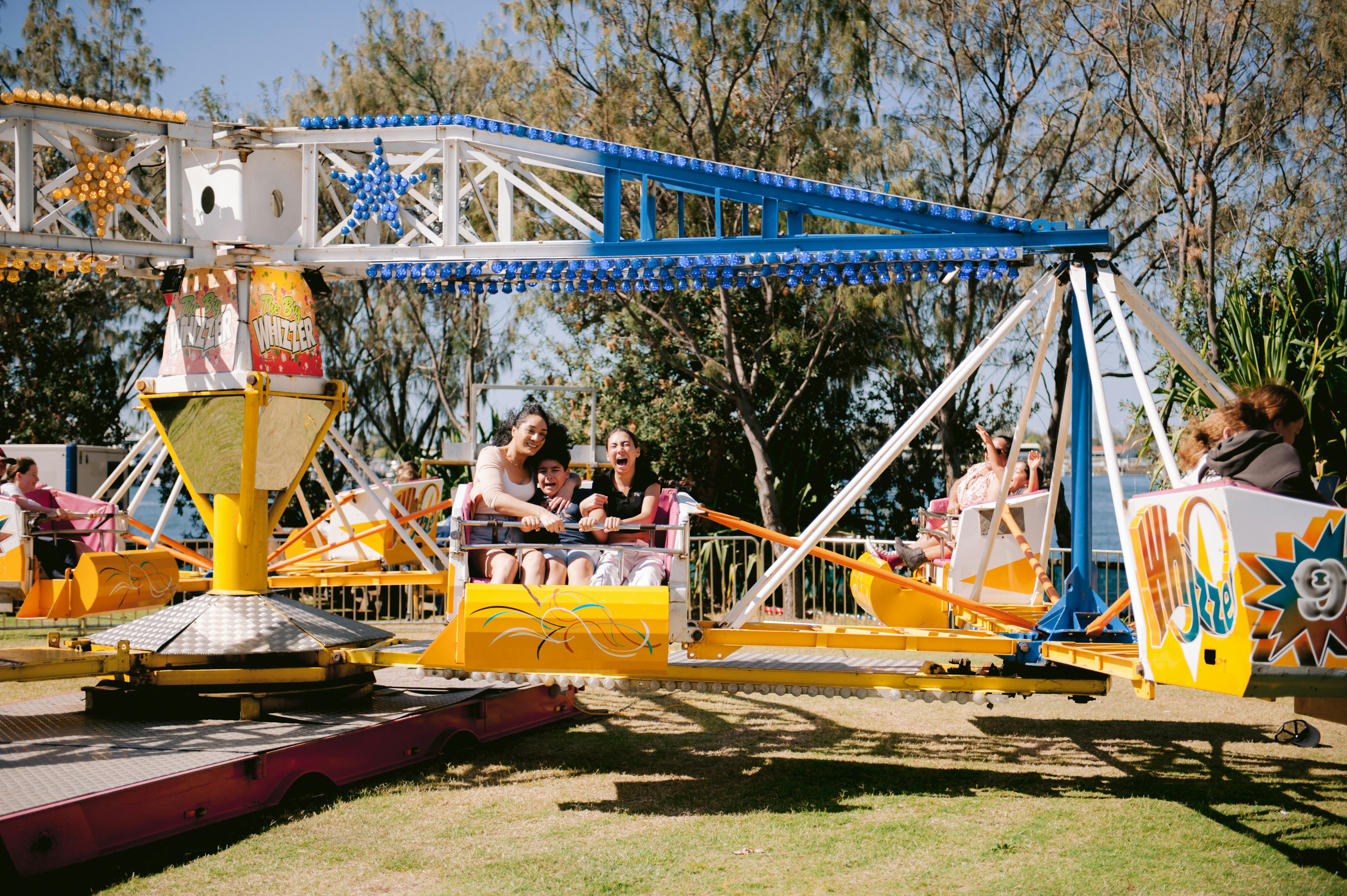 People riding chain carousel in amusement park · Free Stock Photo