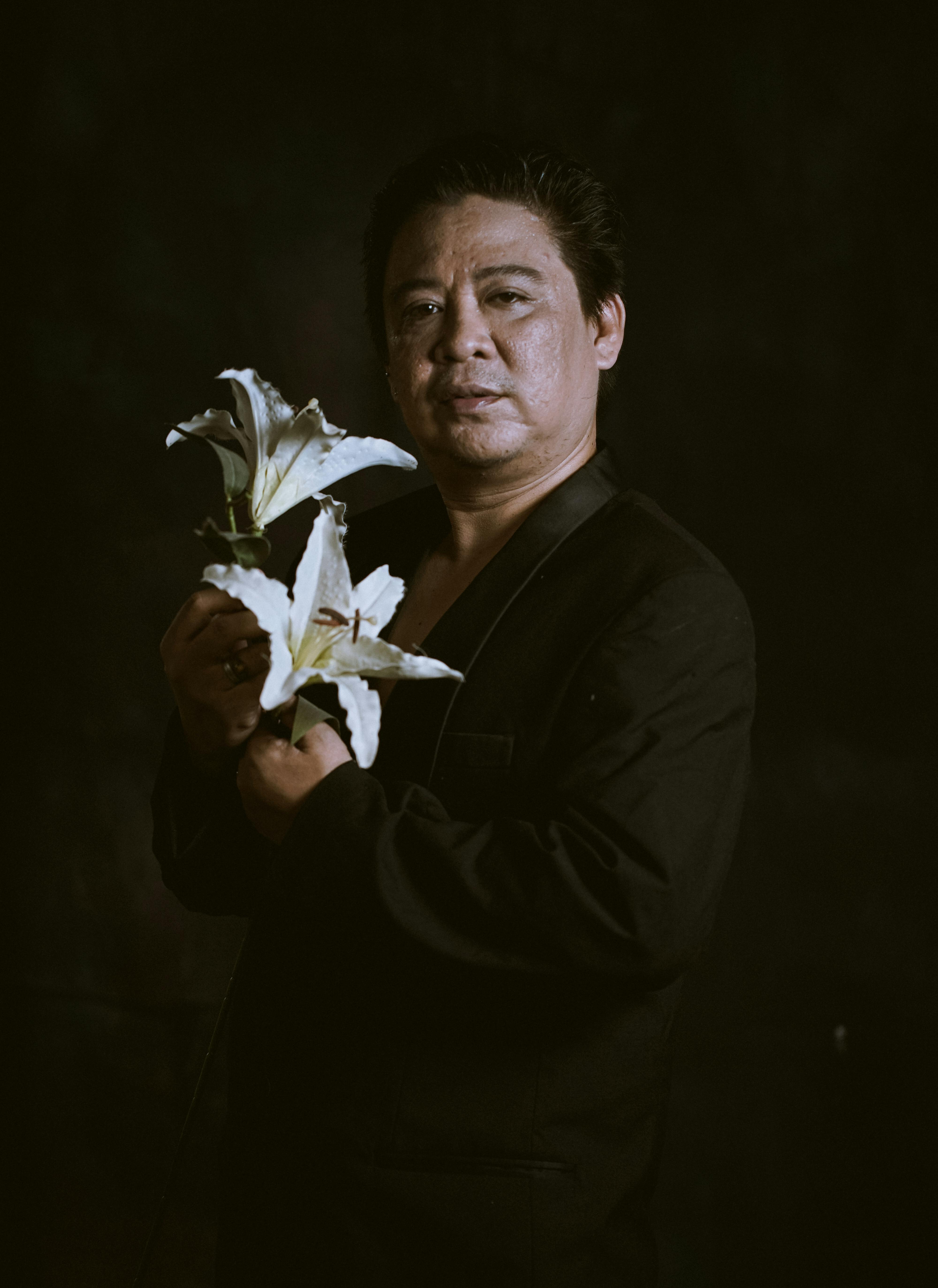 Portrait of a Man Holding Flowers · Free Stock Photo