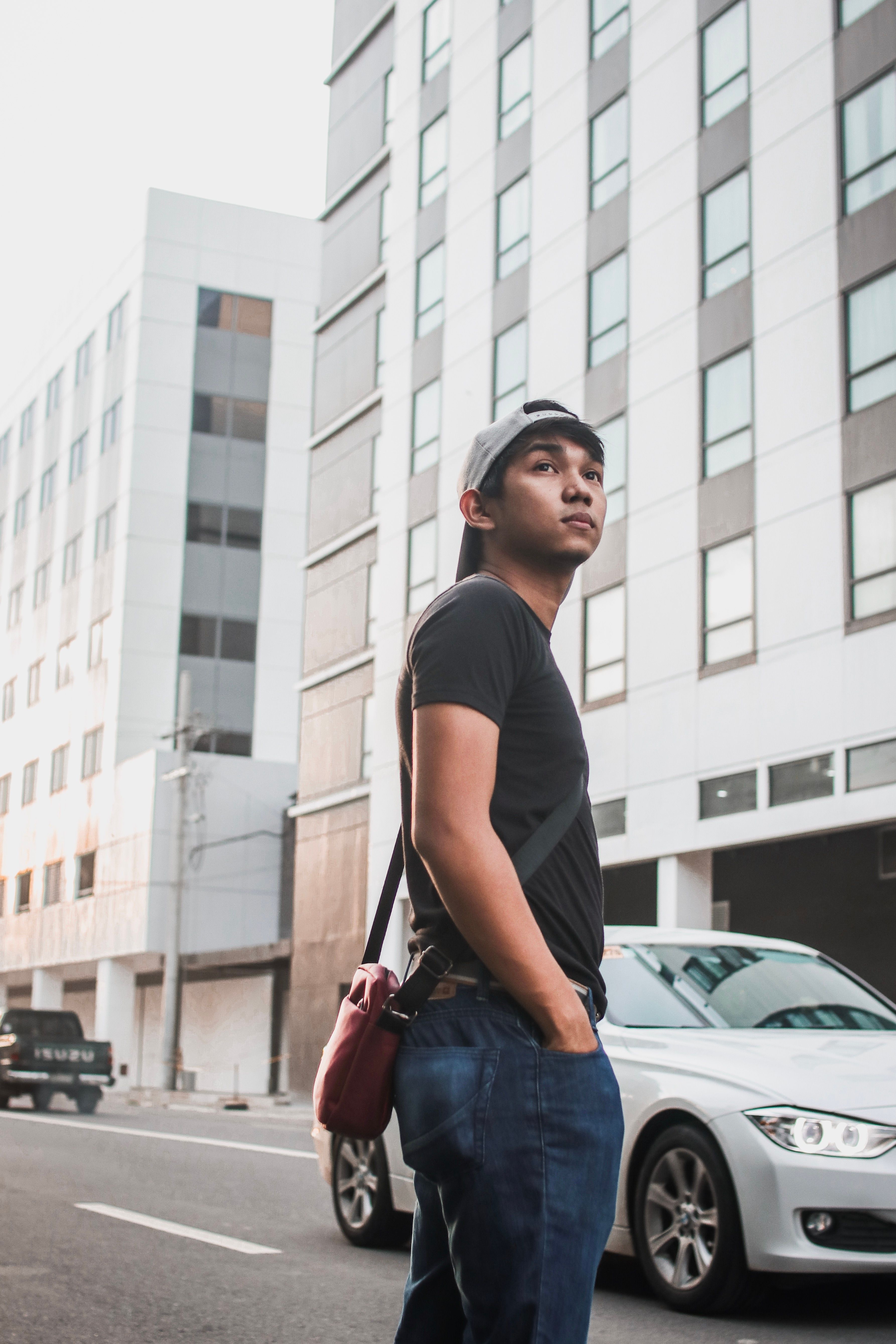 Man Looking Around the City Buildings Standing on the Street · Free ...