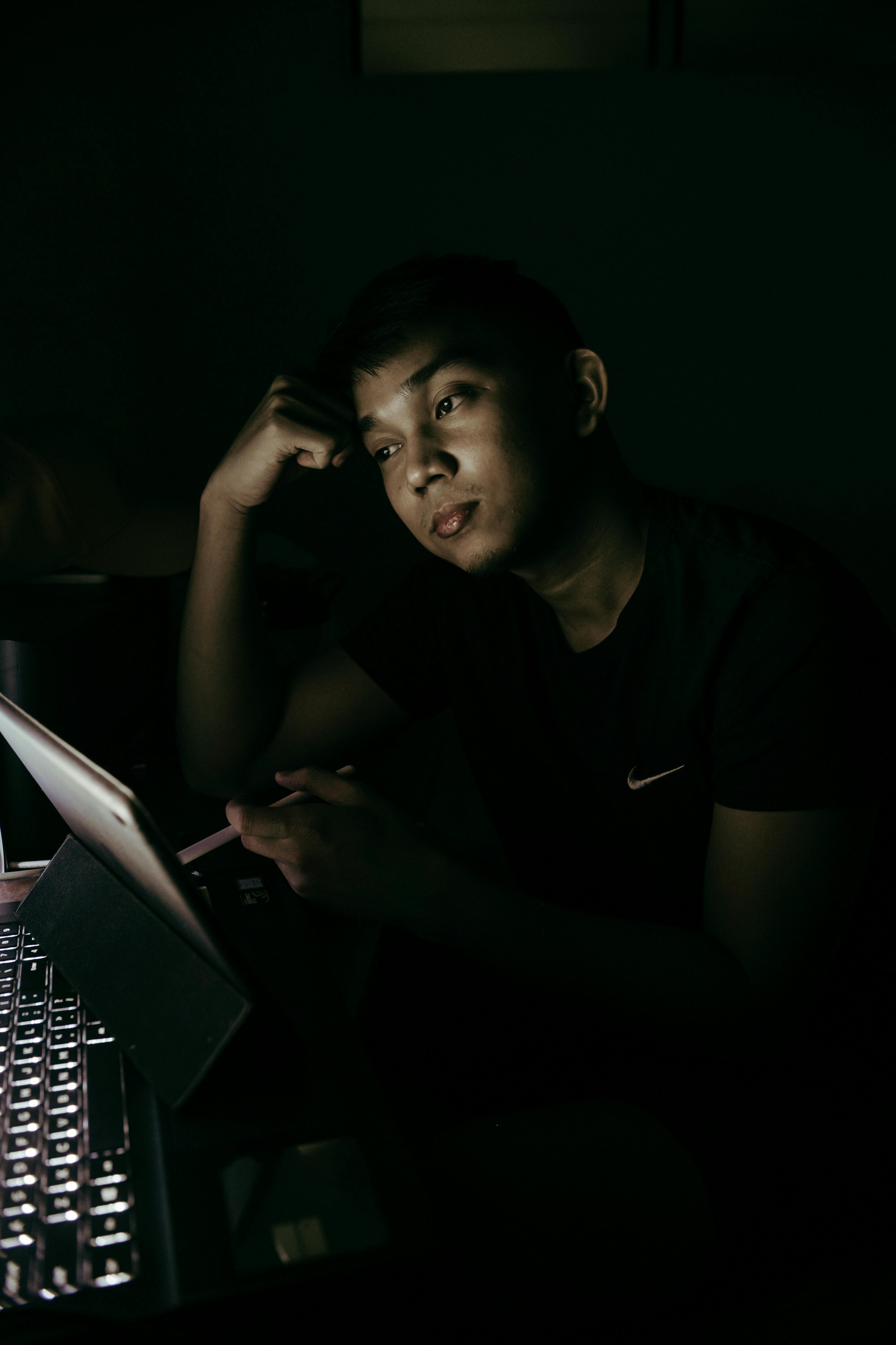 Man Sitting in front of Two Screens · Free Stock Photo