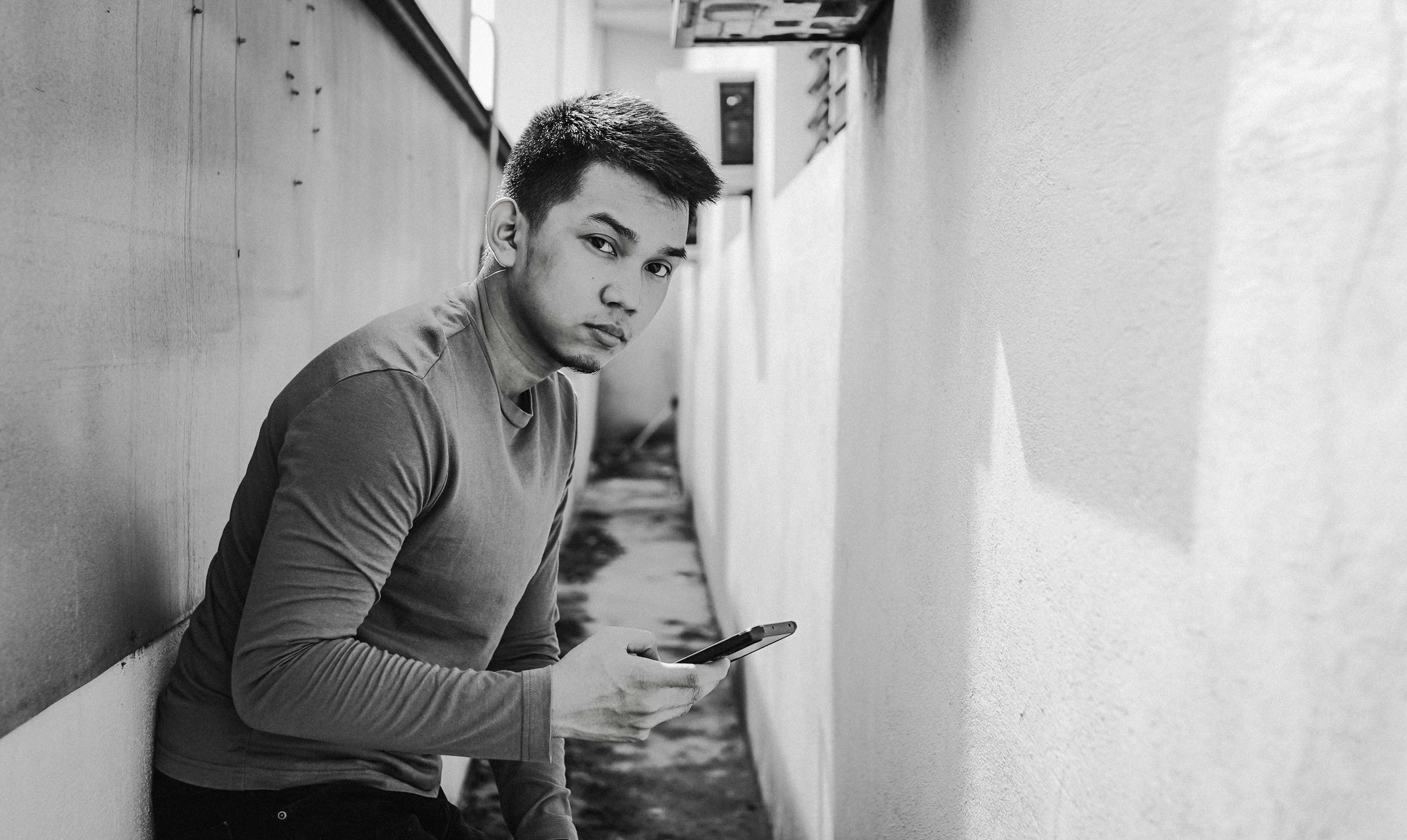 Man Sitting on Pavement with Bags behind · Free Stock Photo