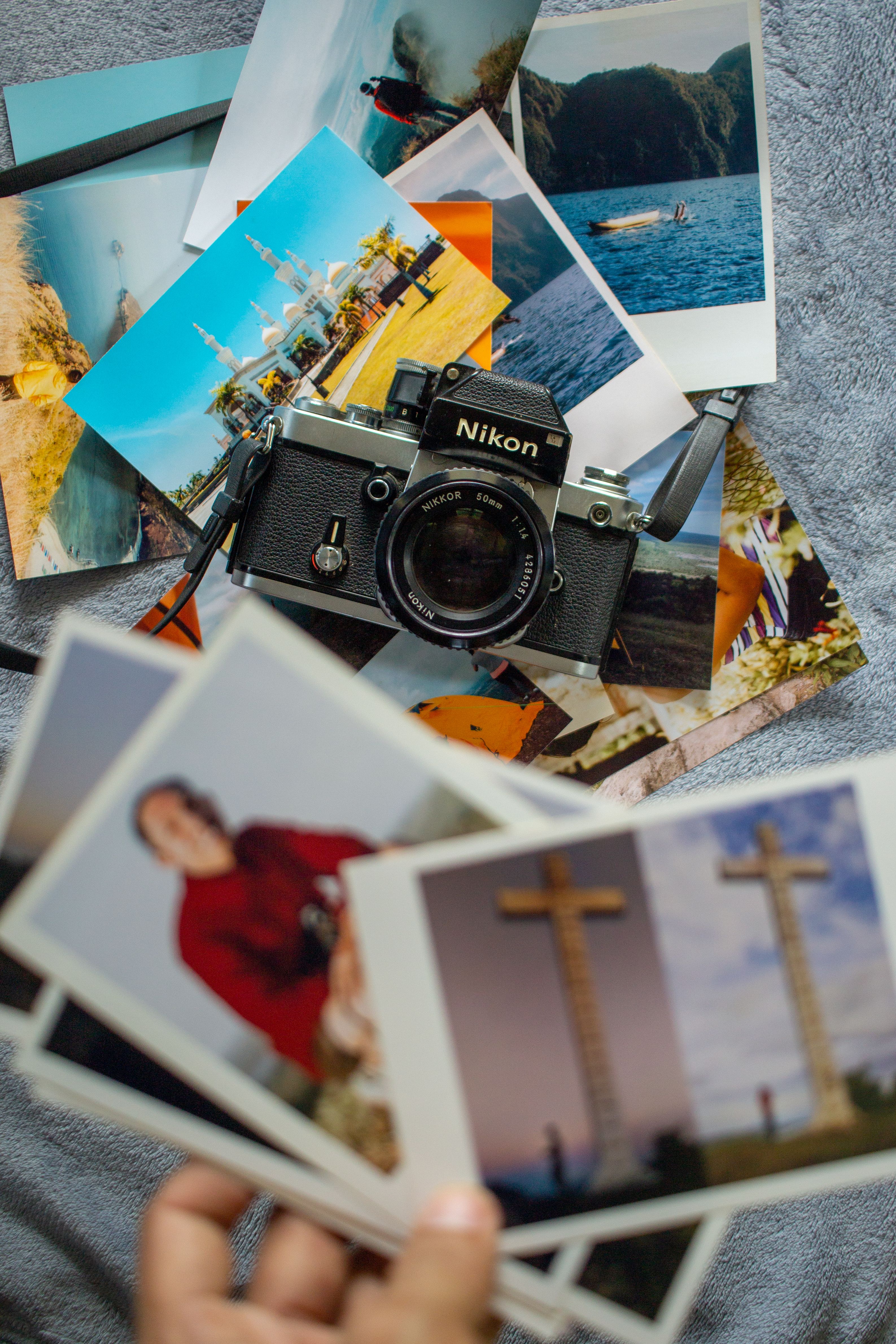 Nikon Analog Camera on Printed Images · Free Stock Photo