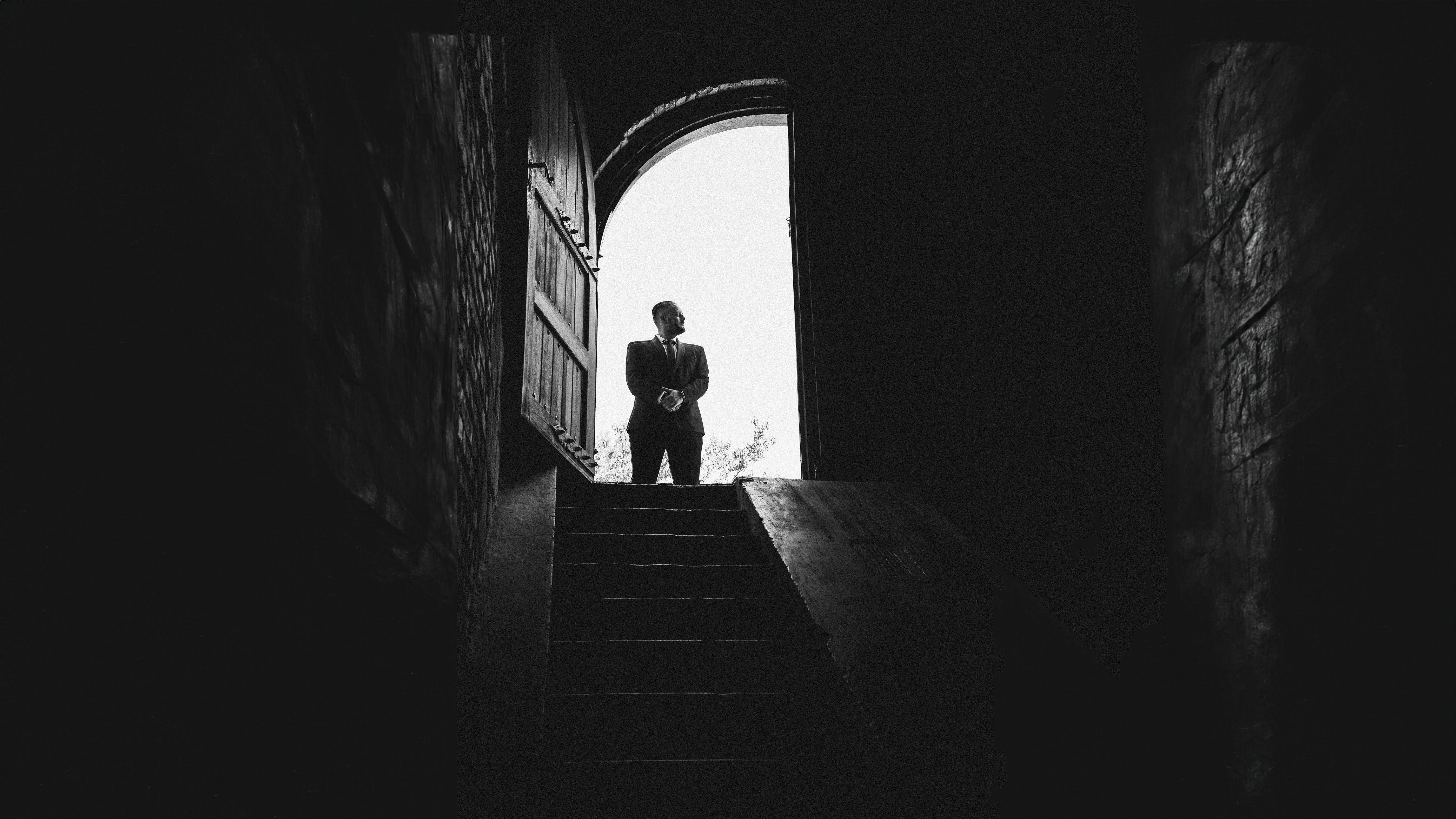 Man in Suit Standing in Basement Door · Free Stock Photo