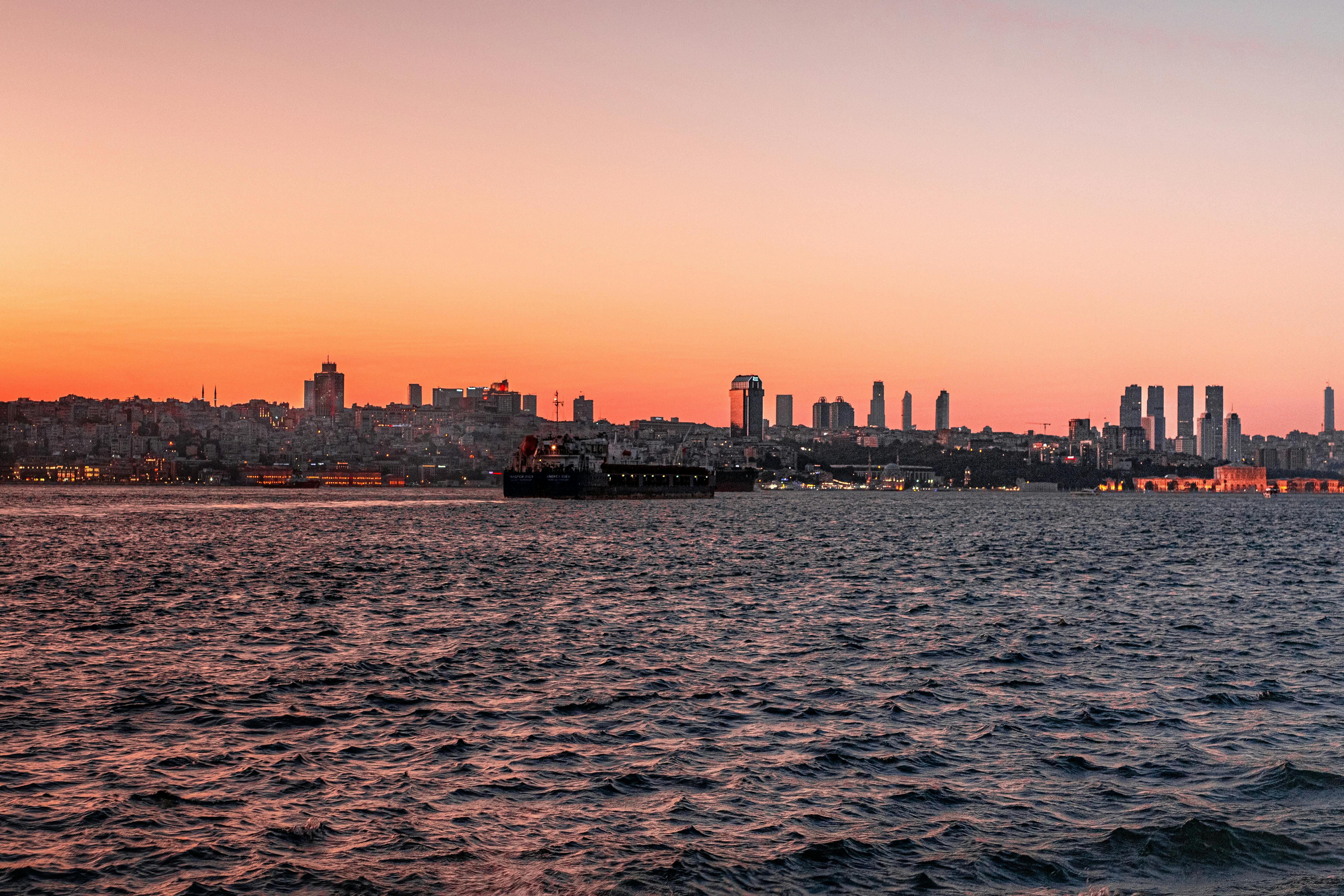 Sea and City Skyline at Sunset · Free Stock Photo