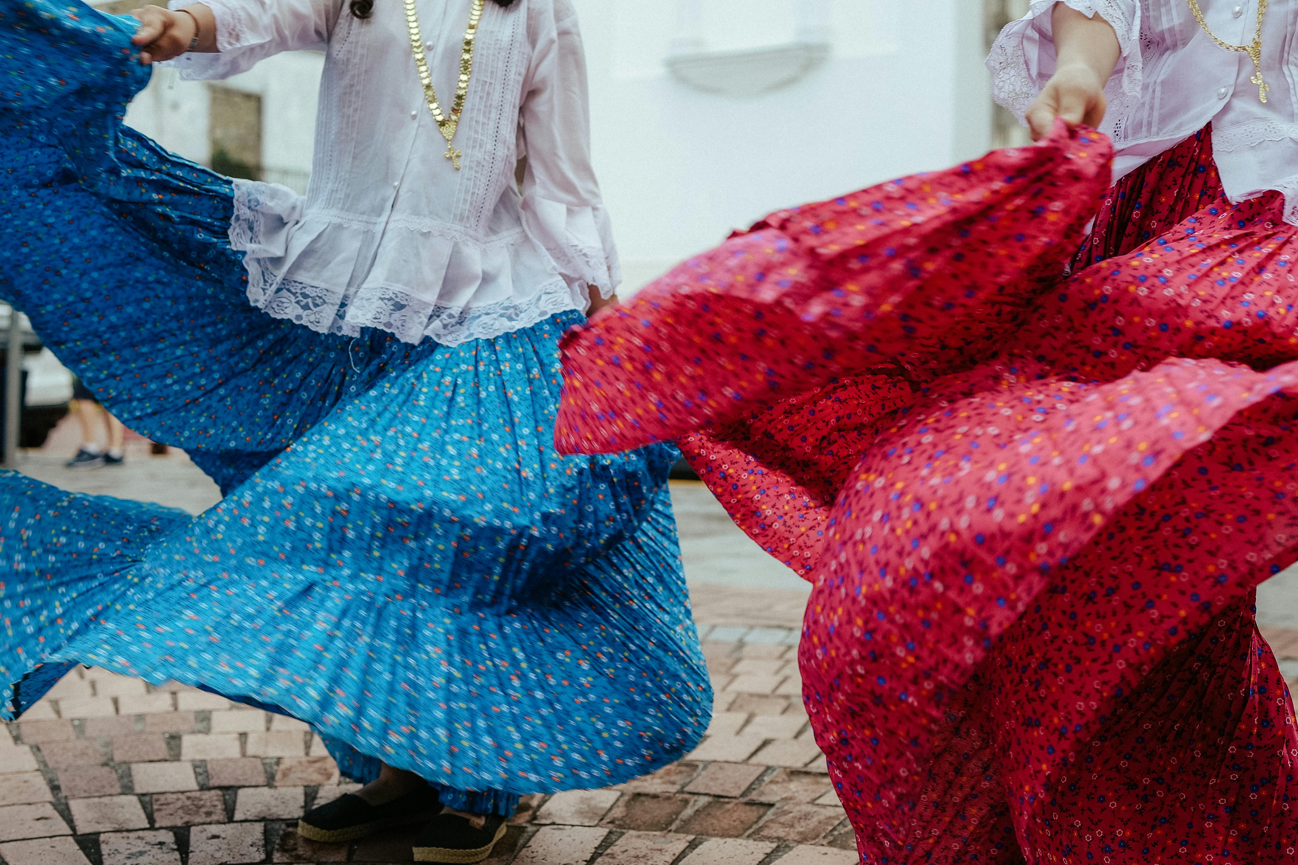 Women Wearing Traditional Outfits Dancing on a Street · Free Stock Photo