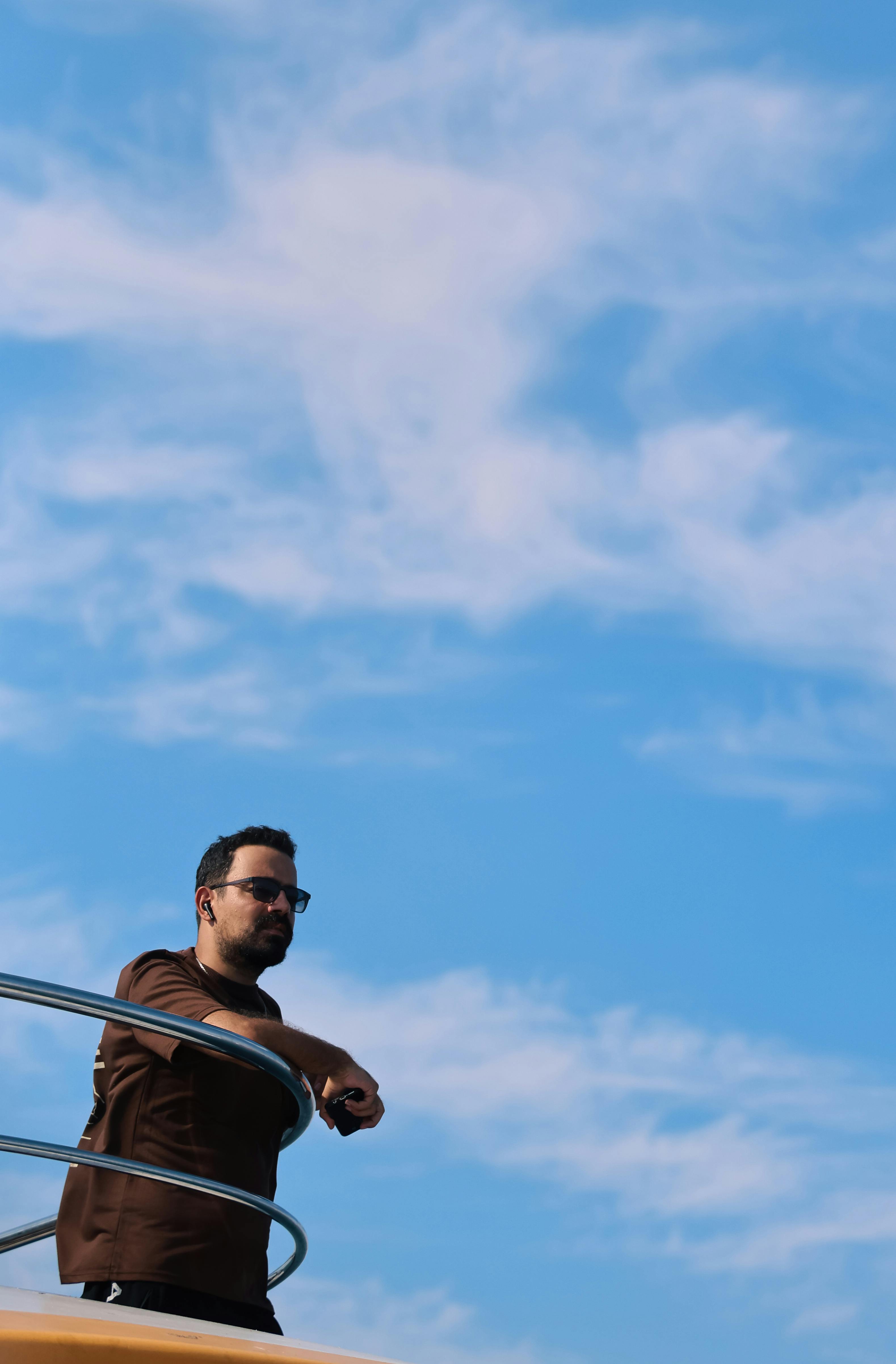 A Man Standing at the front of a Ship · Free Stock Photo