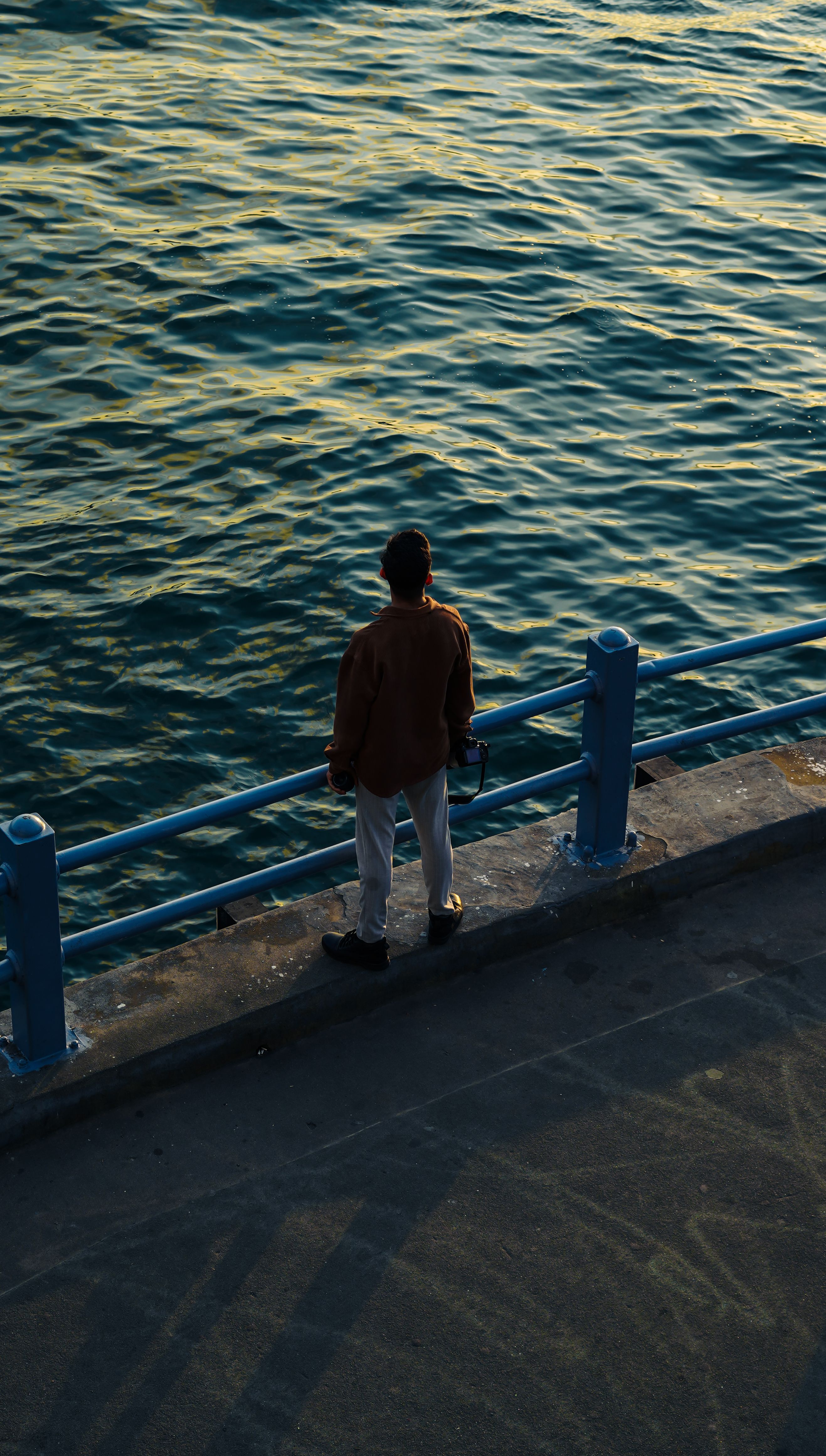 Man Standing on Bridge on Sunset · Free Stock Photo