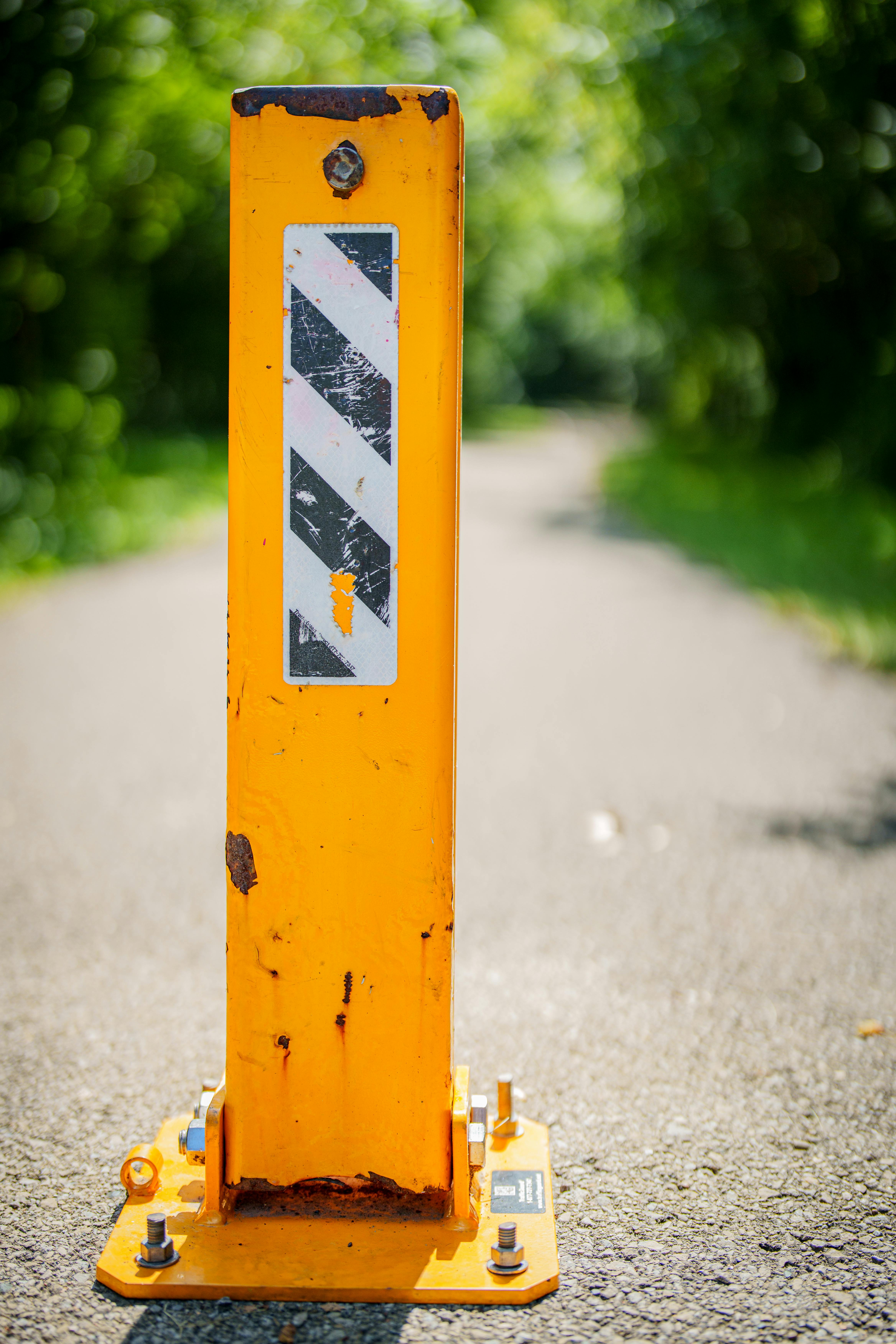 Yellow Traffic Guard Bollard Standing on Asphalt Footpath · Free Stock ...