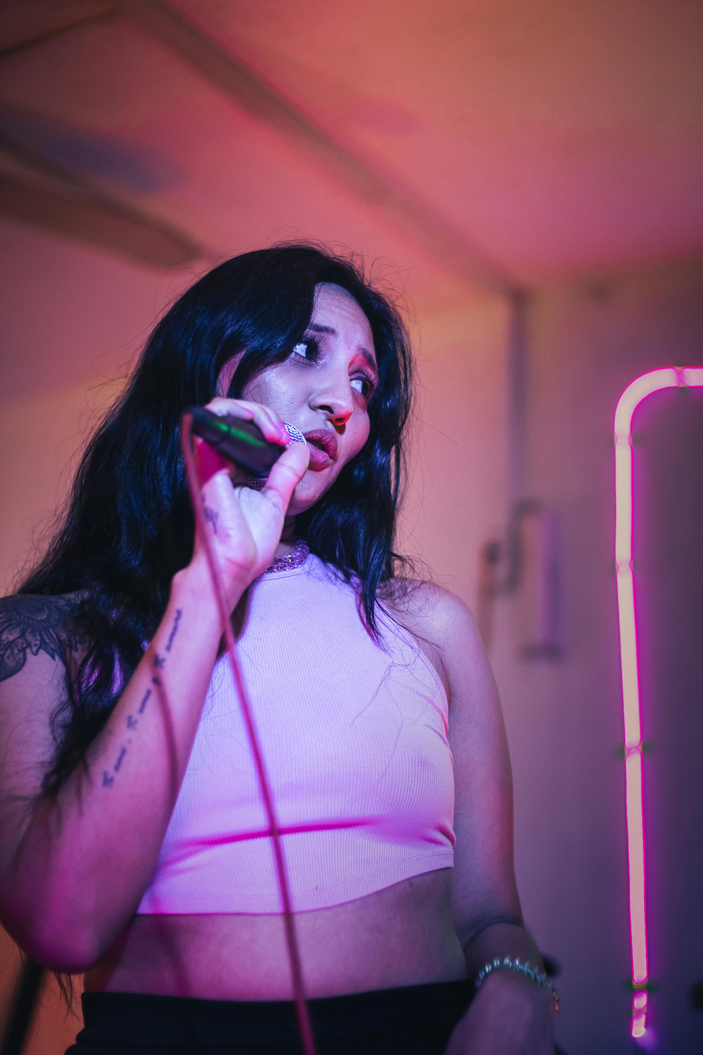 Singer in Red Dress Standing on Stage · Free Stock Photo