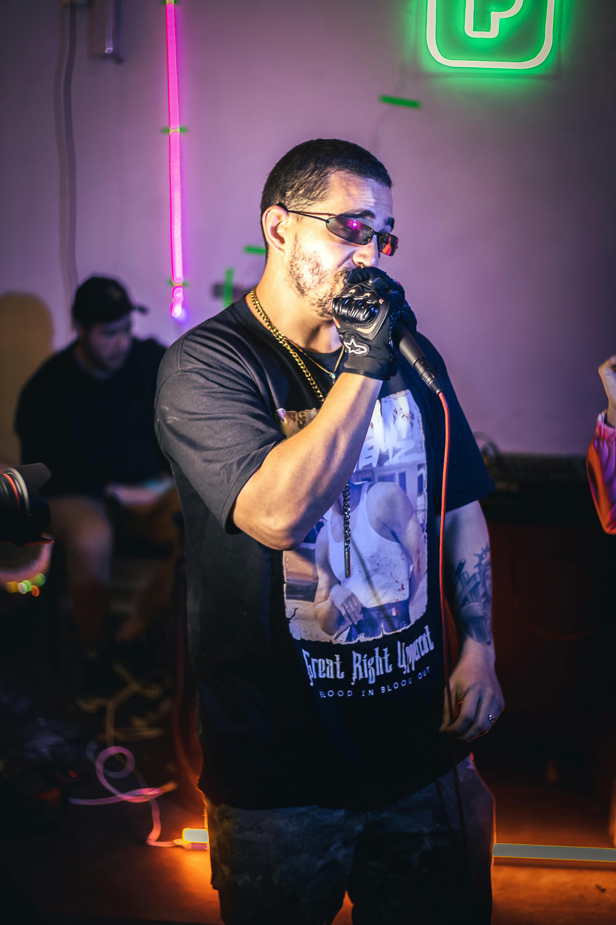 Man Wearing Denim Jacket Singing on Stage · Free Stock Photo