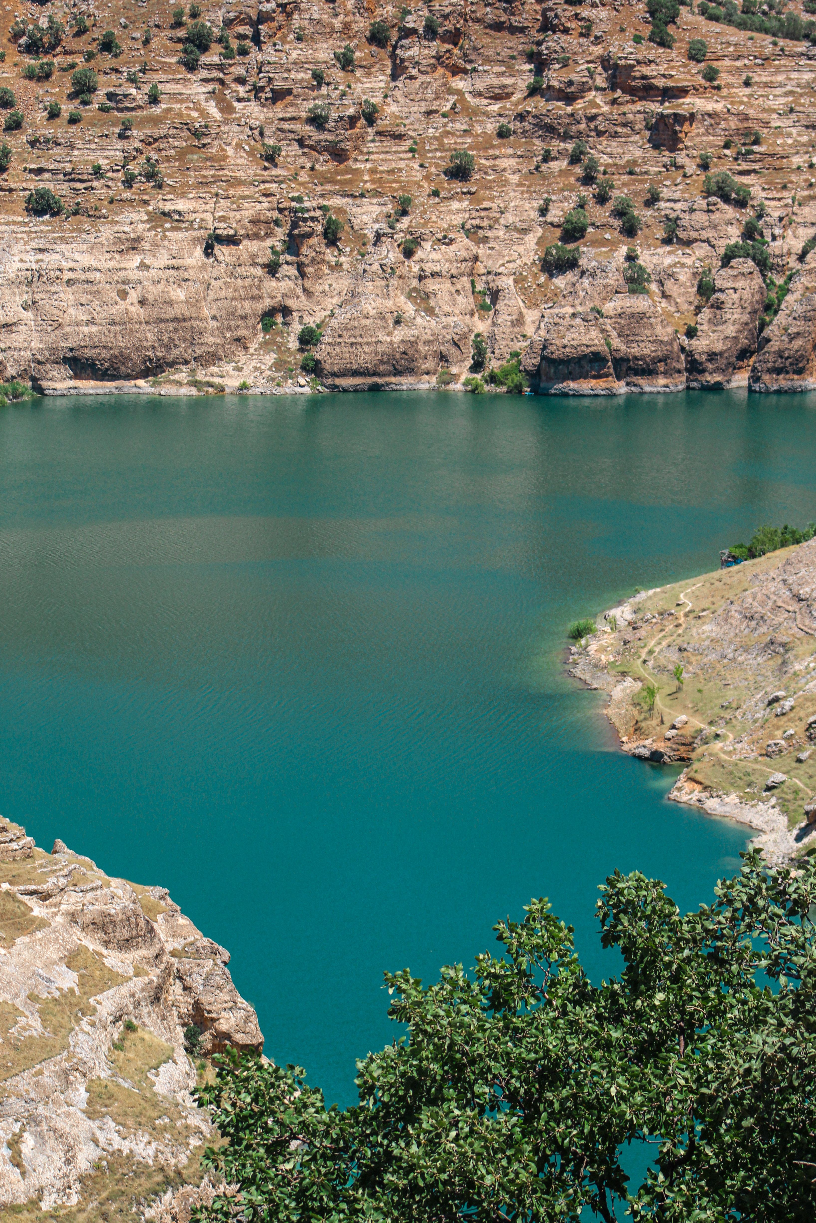 Arid Hill over Lake · Free Stock Photo