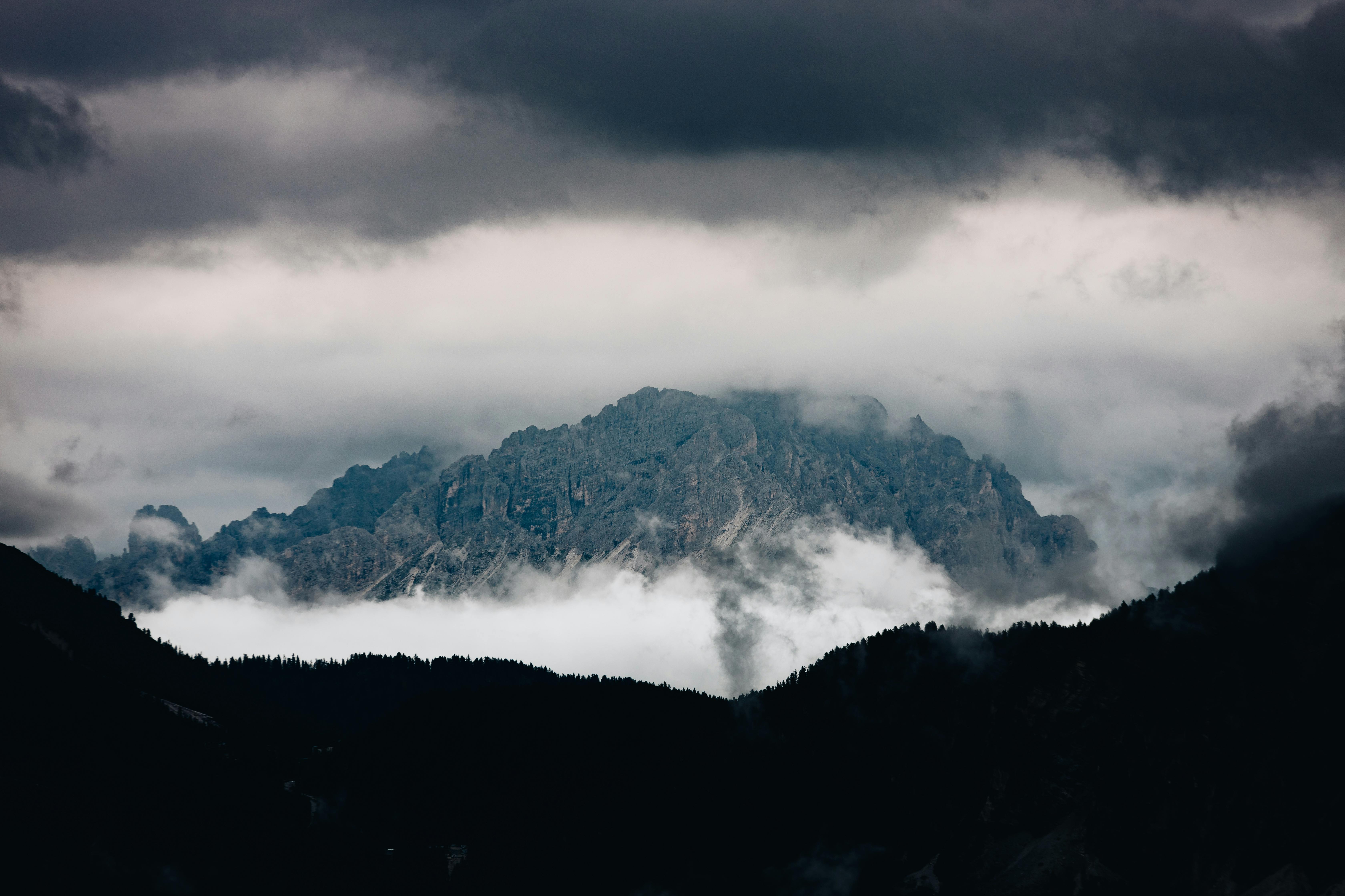 View of a Dark Rocky Mountain under a Cloudy Sky · Free Stock Photo