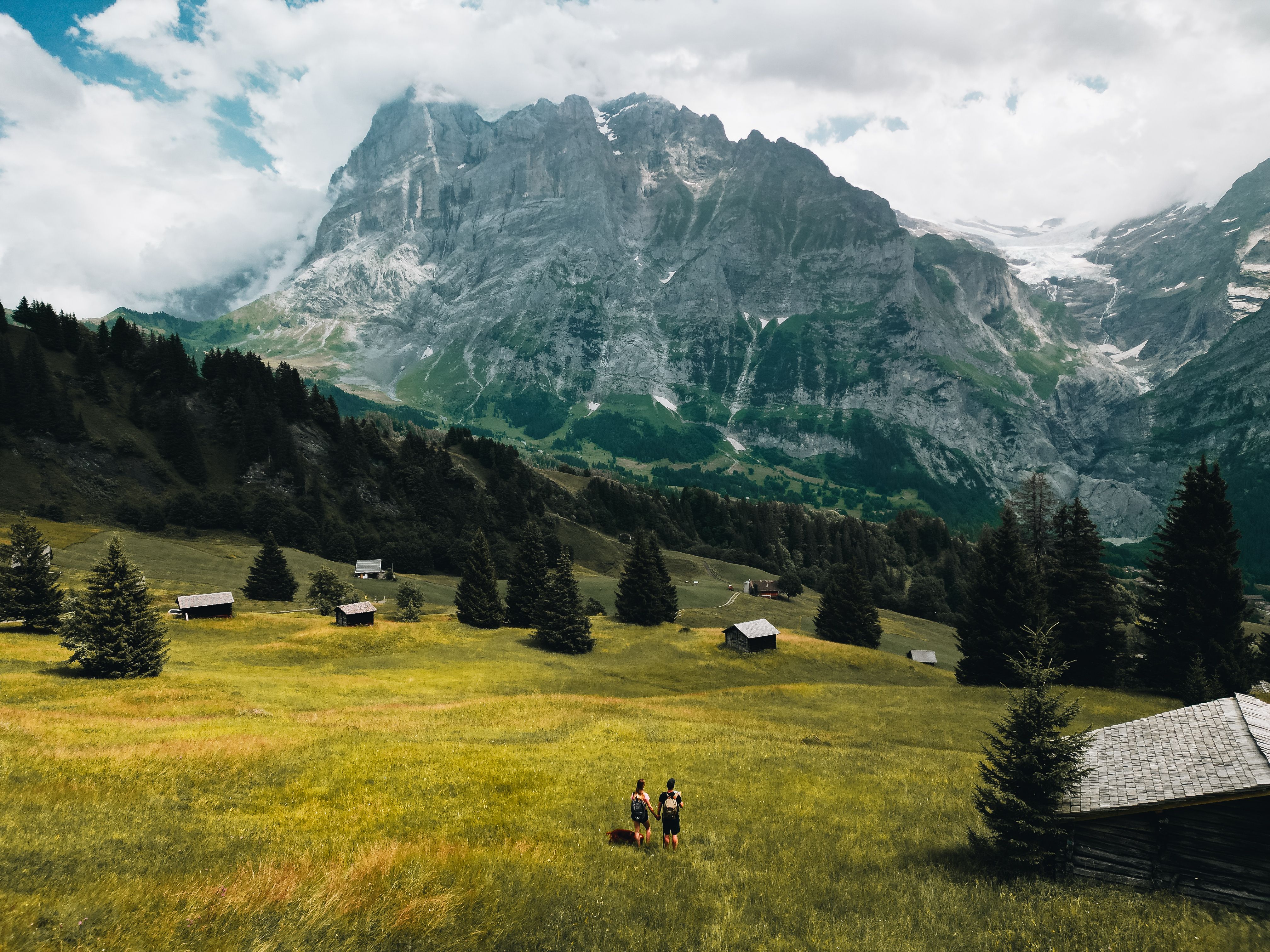 Couple of Hikers on a Mountainside in the Swiss Alps · Free Stock Photo