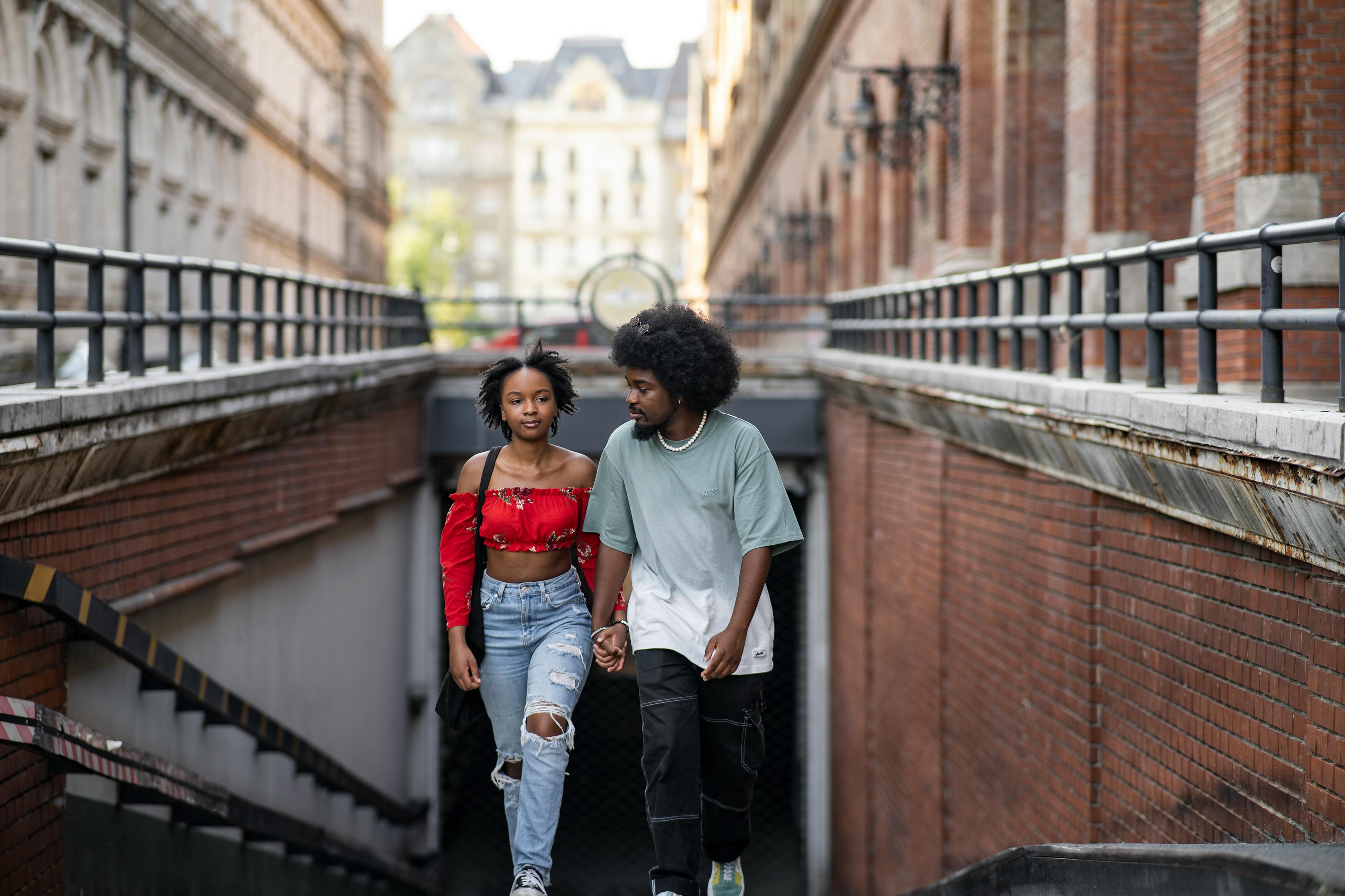 Couple Holding Hands Walking out of Underground Passage · Free Stock Photo