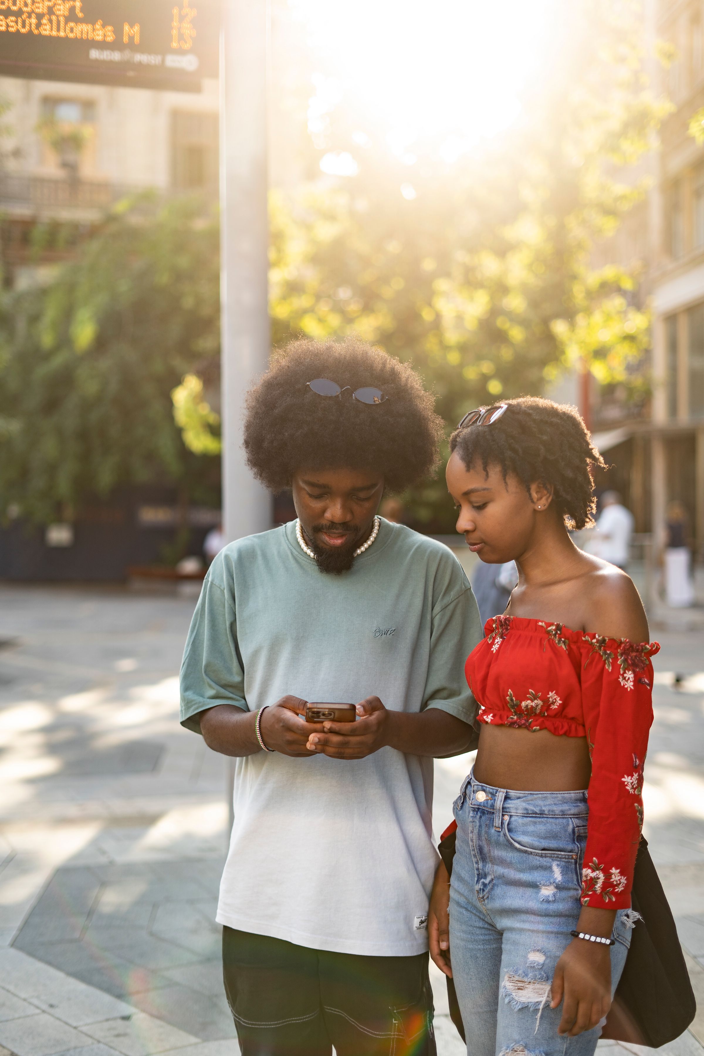 Couple Looking Through Photos on Smartphone Waiting for the Bus · Free ...