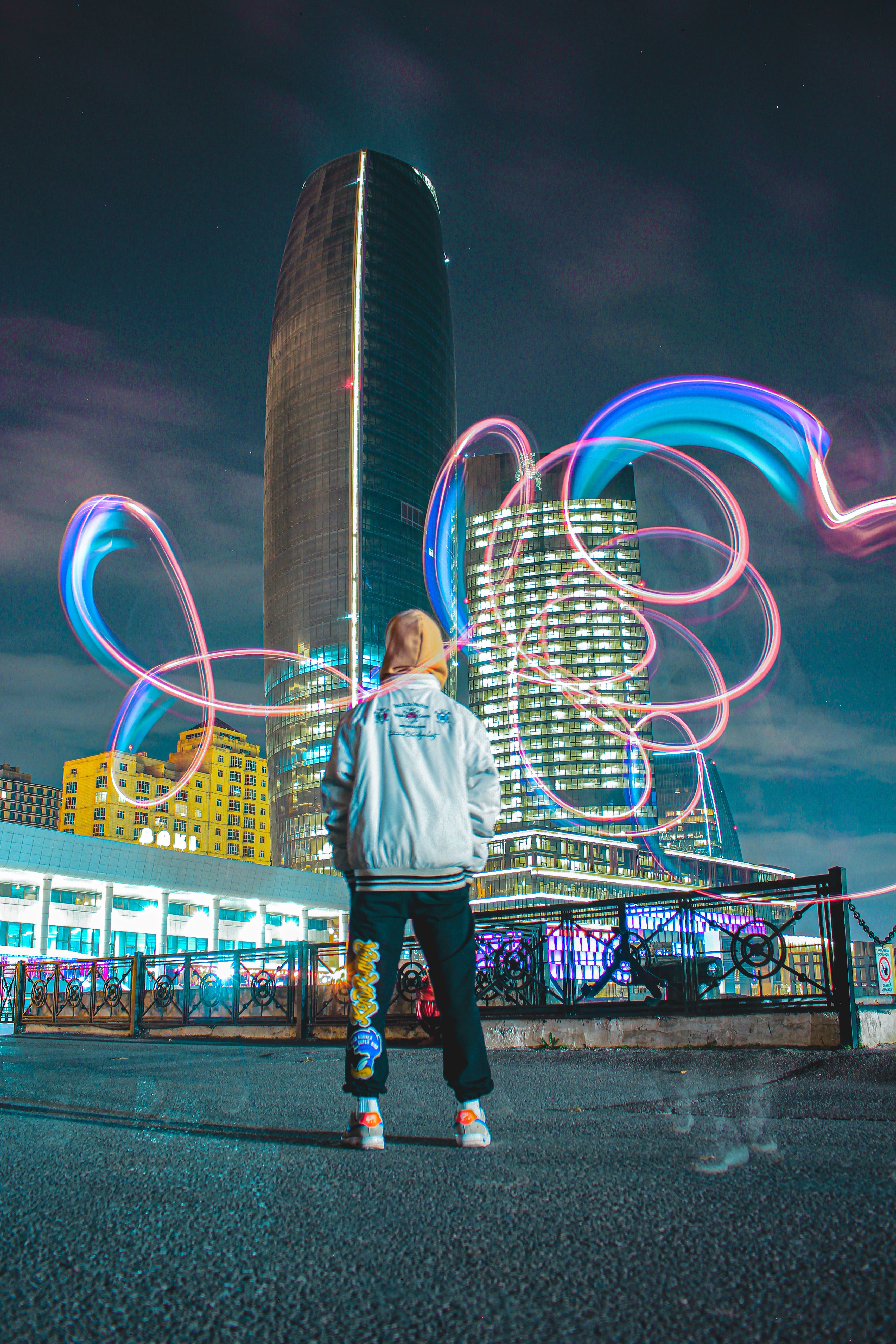 Back View of a Person Standing in City in the Evening · Free Stock Photo