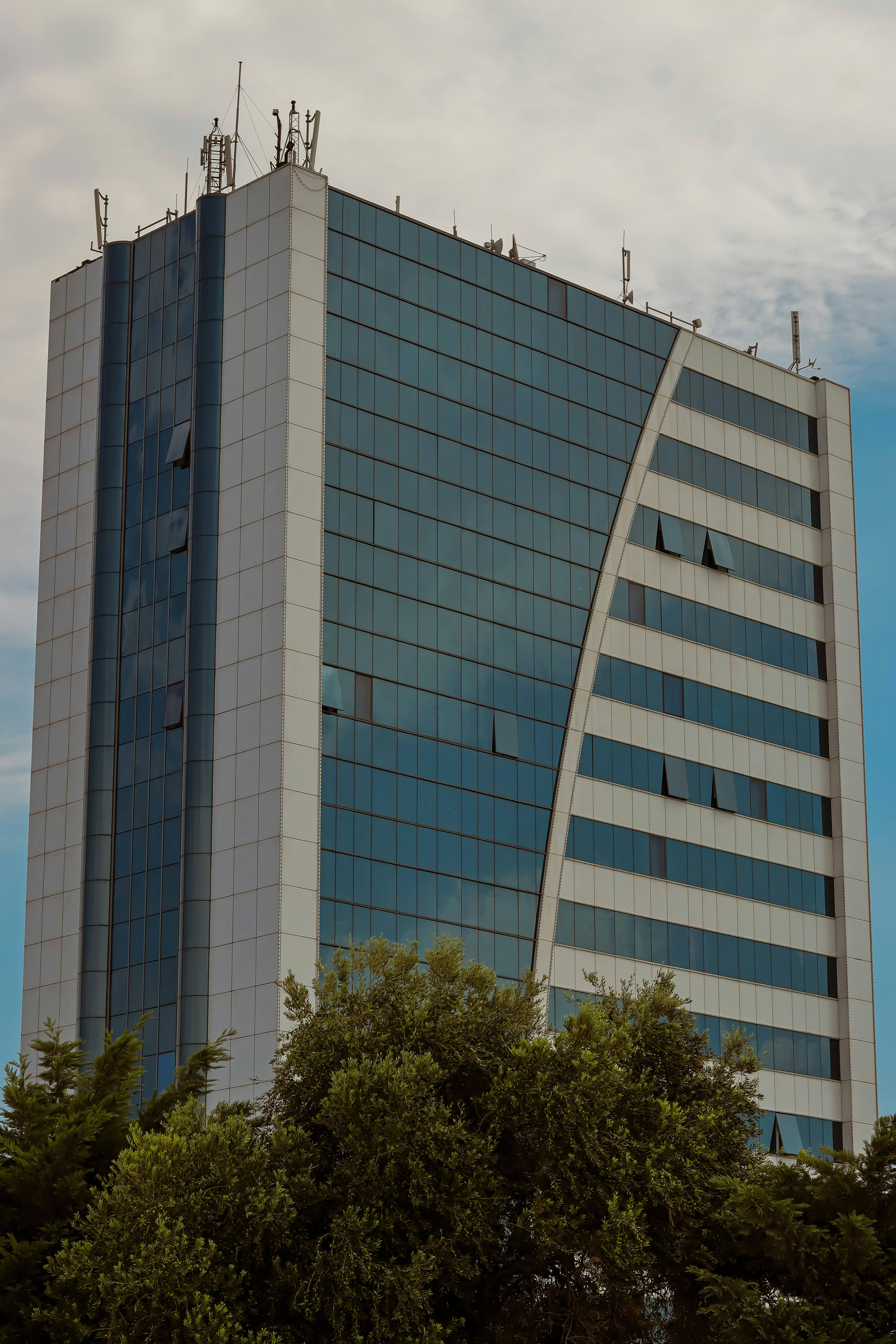 Grey Concrete Round High Rise Building · Free Stock Photo