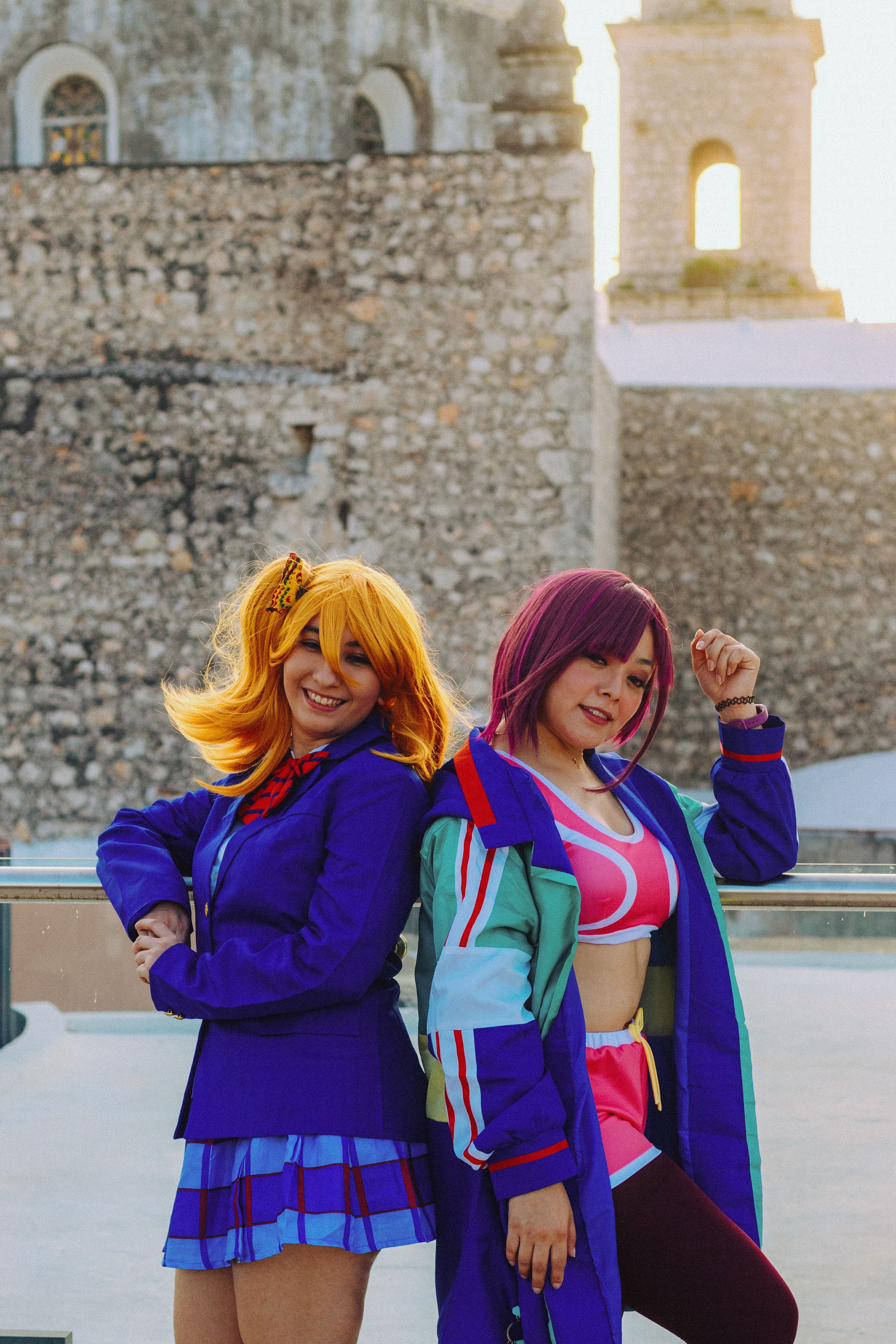 Two Young Women Posing in Blue Cosplay Costumes and Wigs · Free Stock Photo