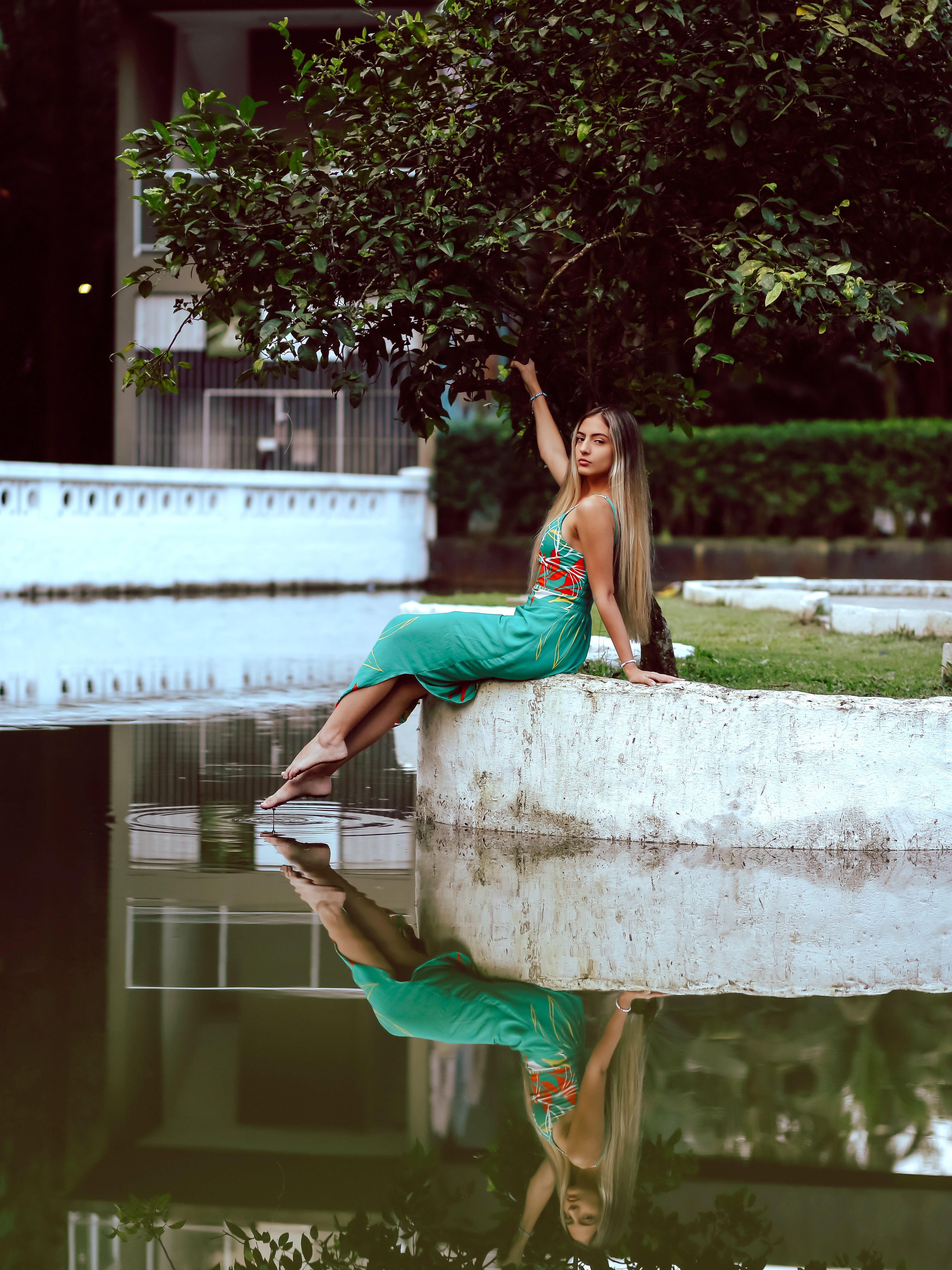 Young Woman in Green Dress Posing by Pond · Free Stock Photo