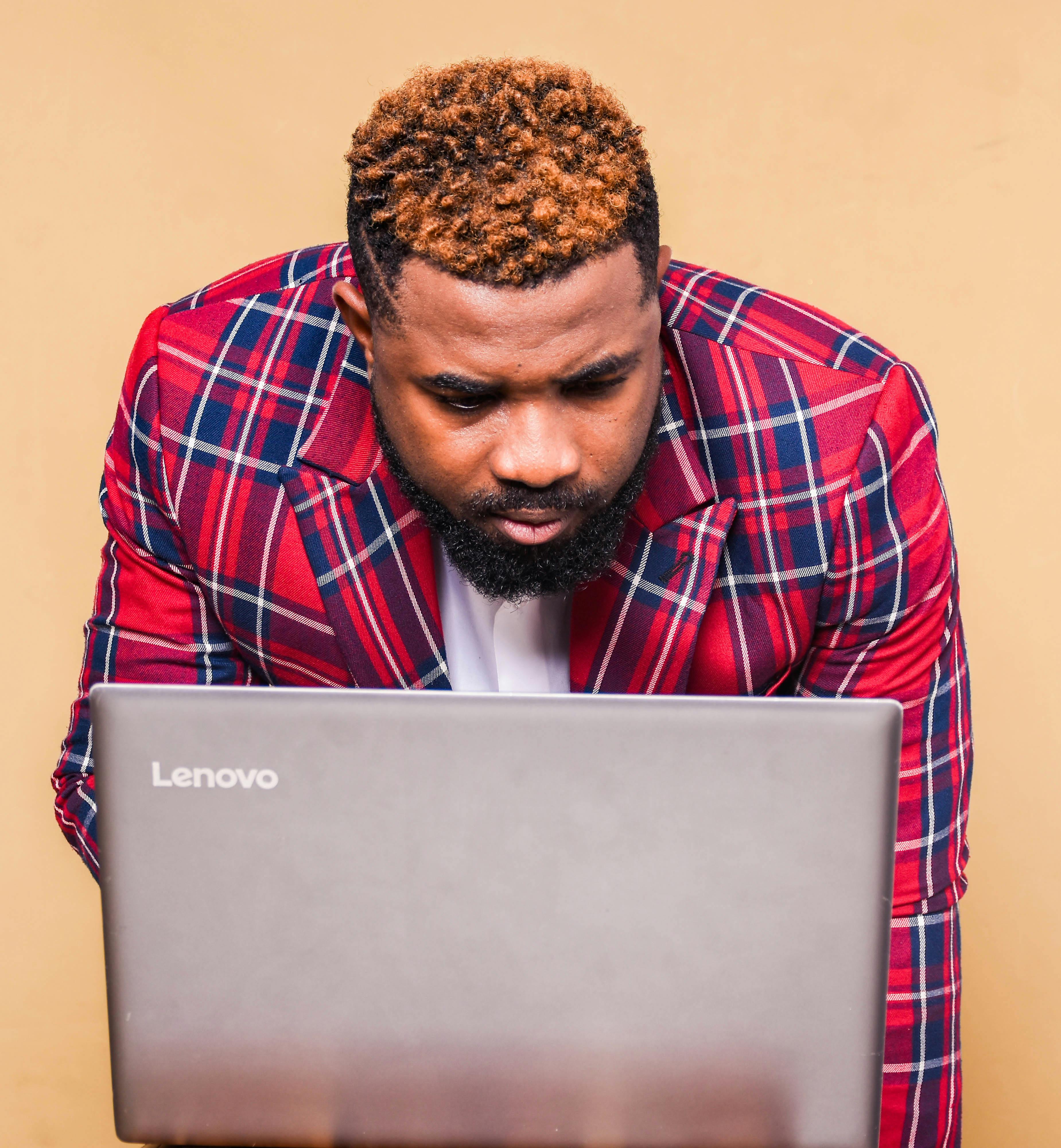 Man in White Crew Neck T-shirt Holding Laptop · Free Stock Photo