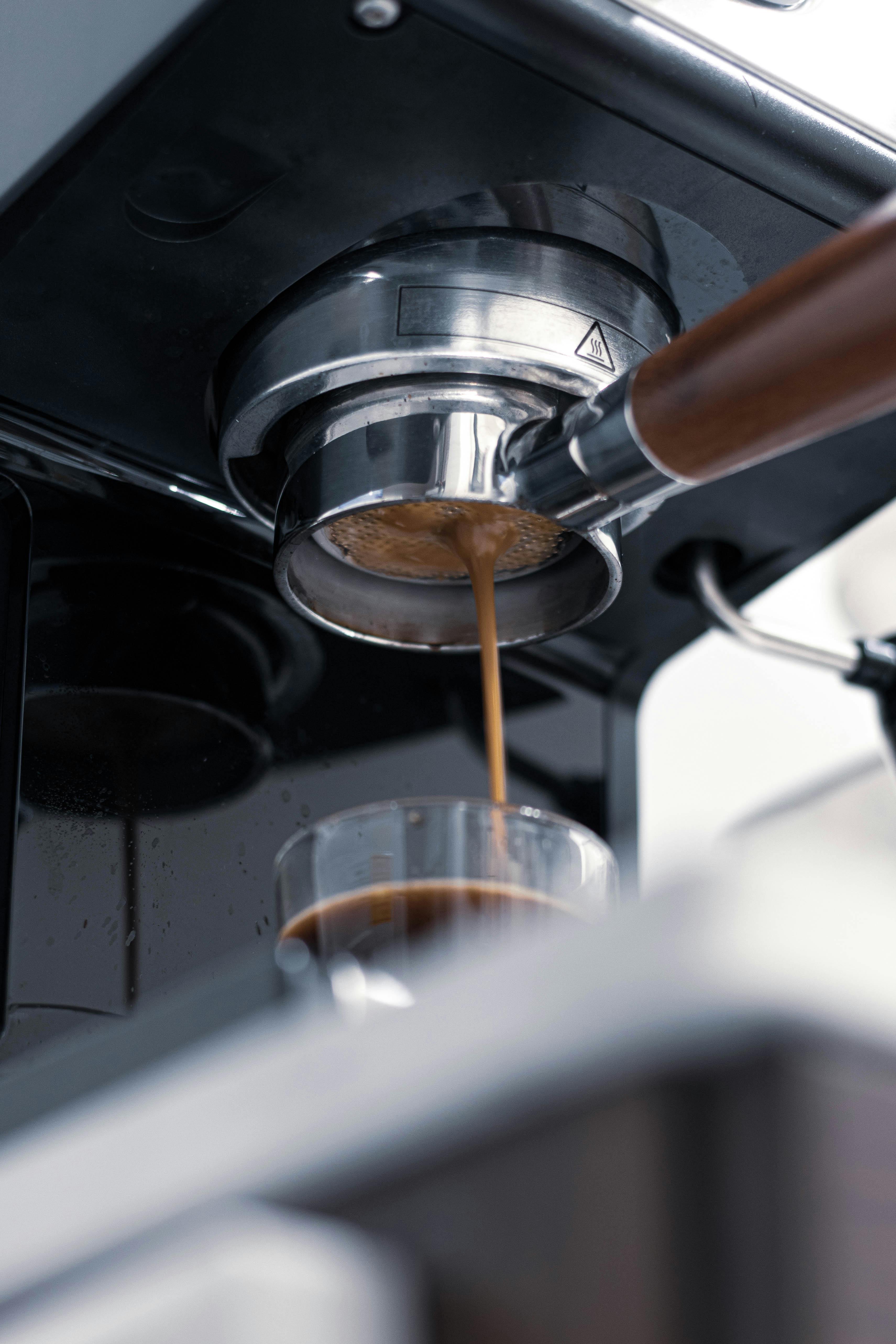 A Stainless Steel Espresso Machine Brewing Coffee · Free Stock Photo