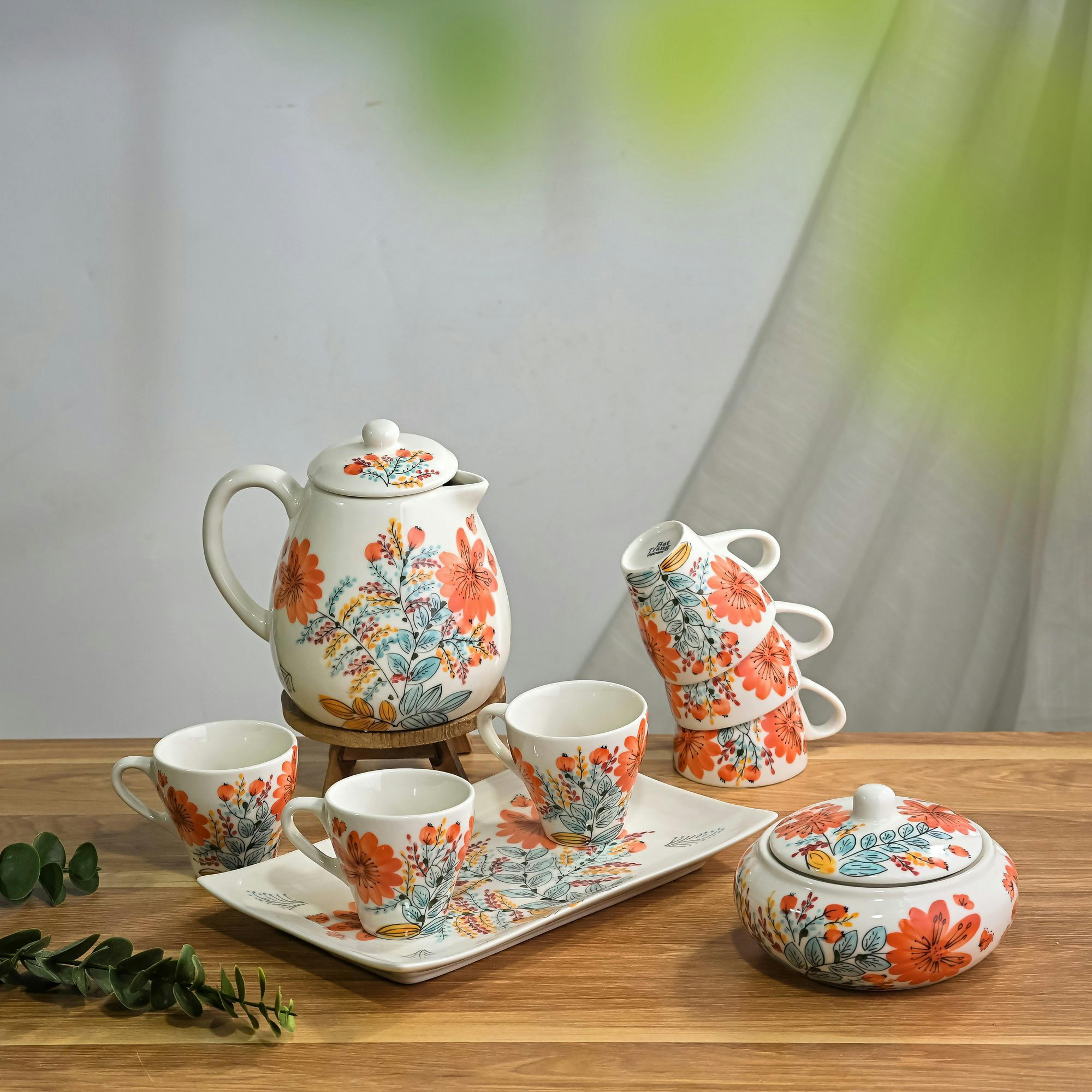 Teapot with ornamental cups on table in house room · Free Stock Photo